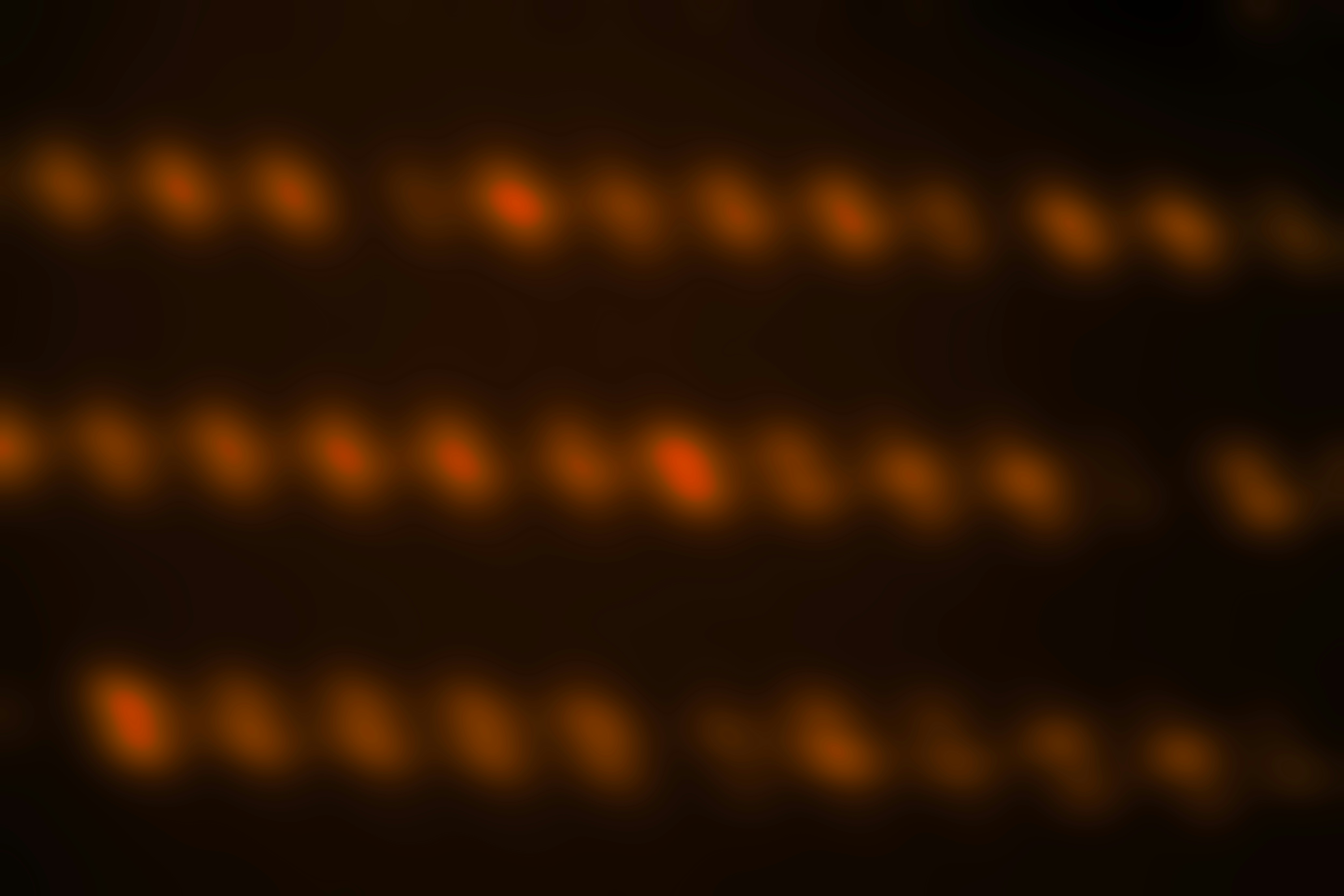 Rows of Warm Dots: Blurred Signals Across Dim Studio Light