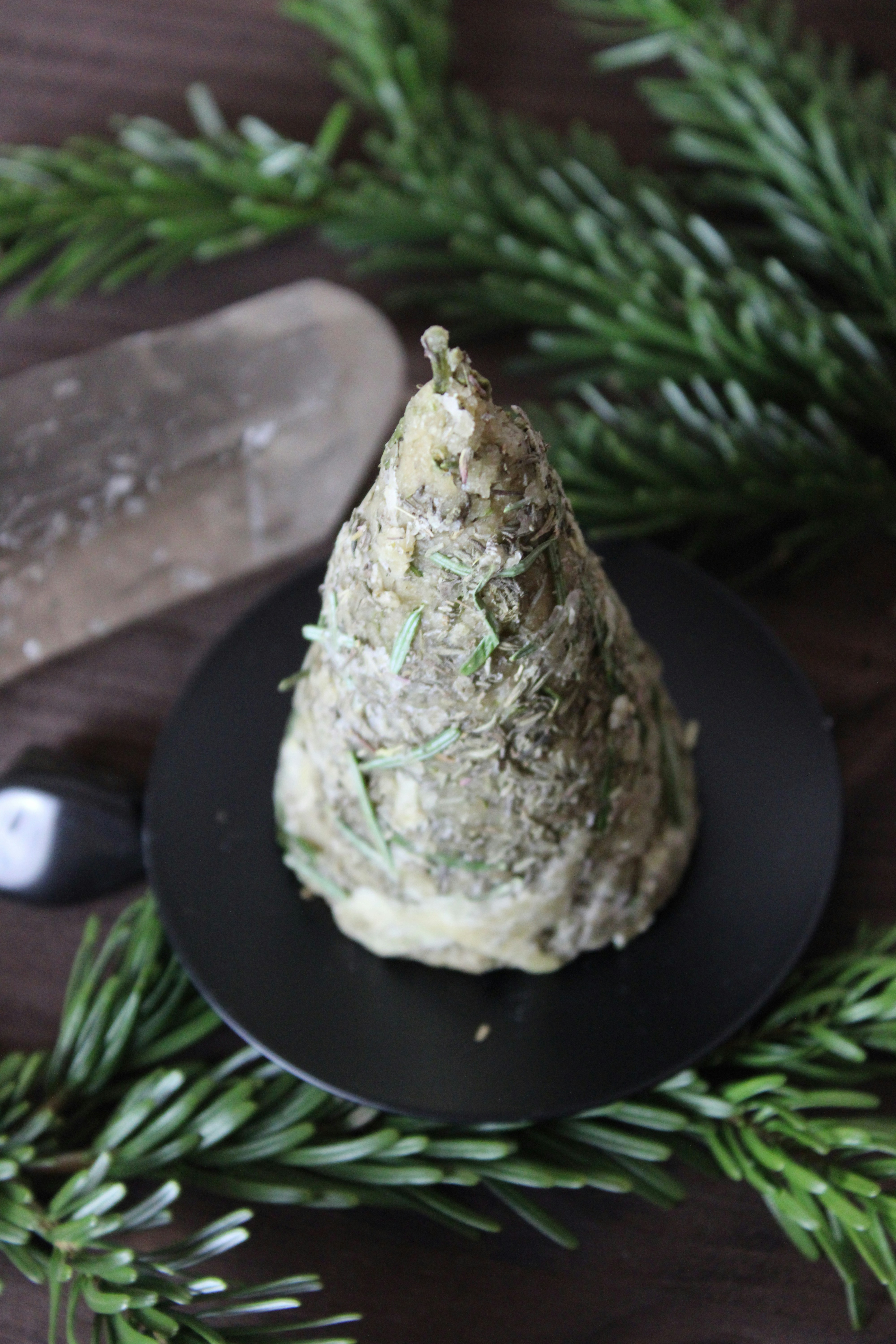 Herb-Crusted Cone on a Wide Black Platter