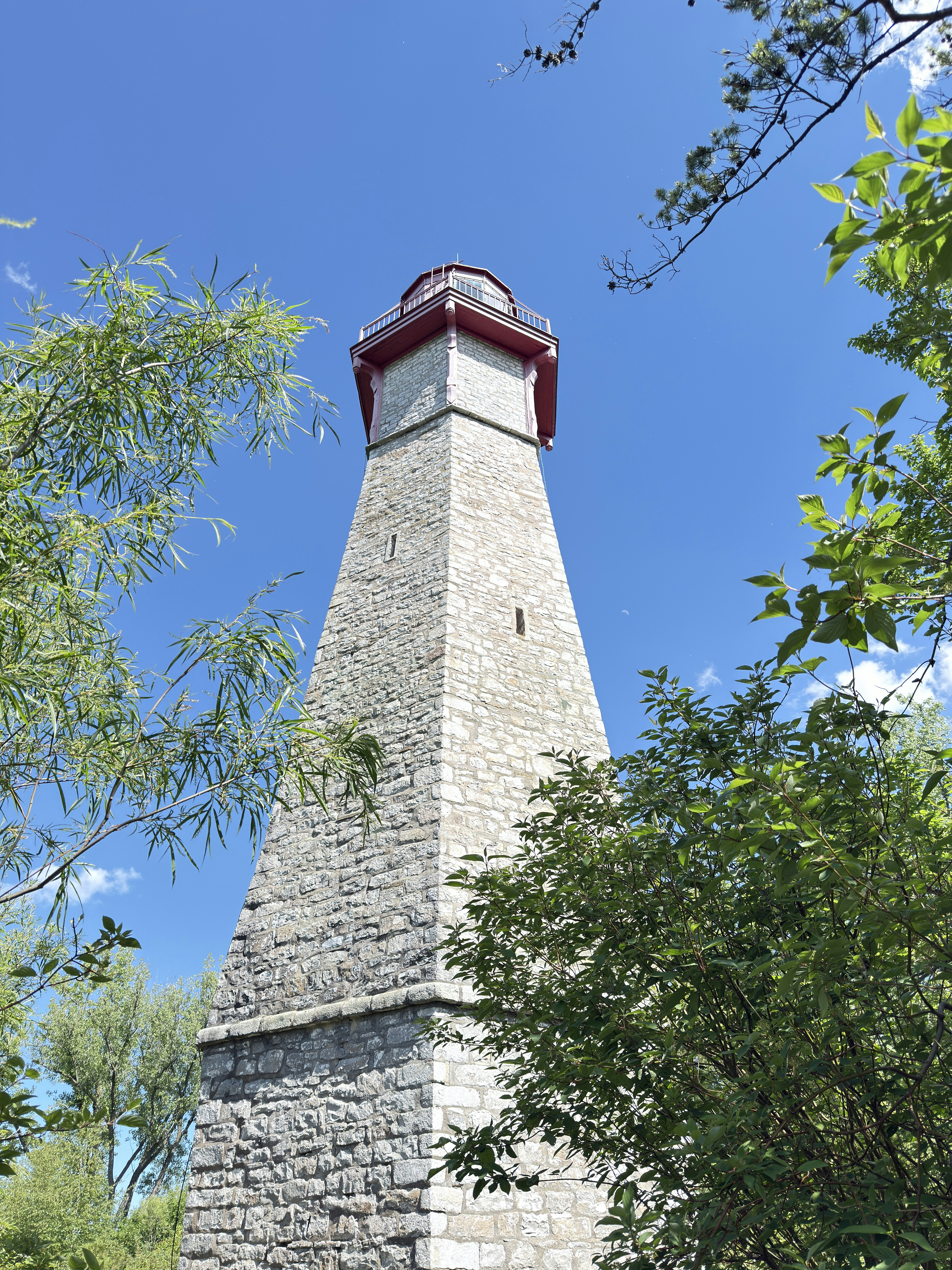 Towering Stone Beacon Under a Bright Blue Sky