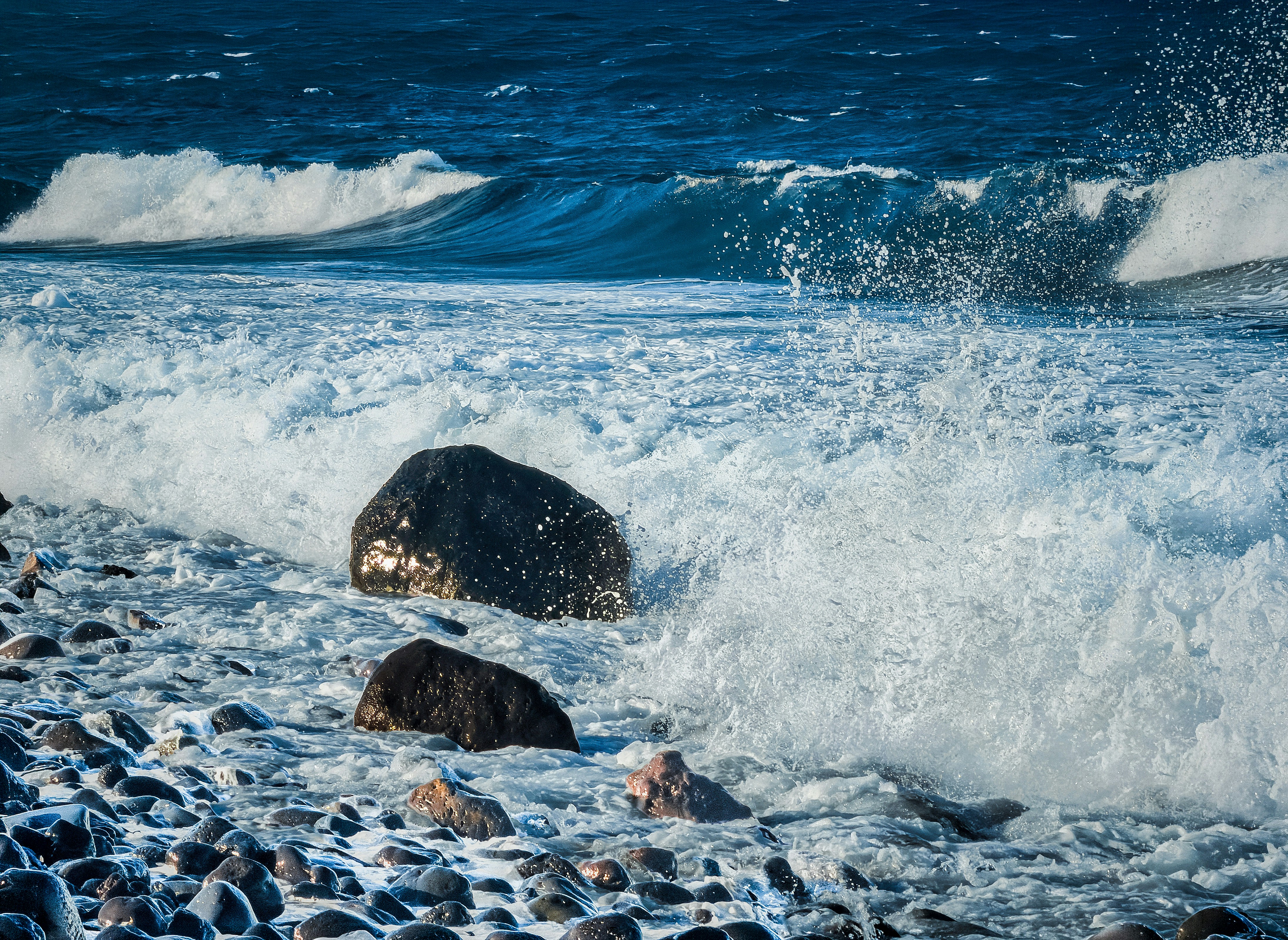 Pebble Beach Break: Foam and Rocks Meet the Tide