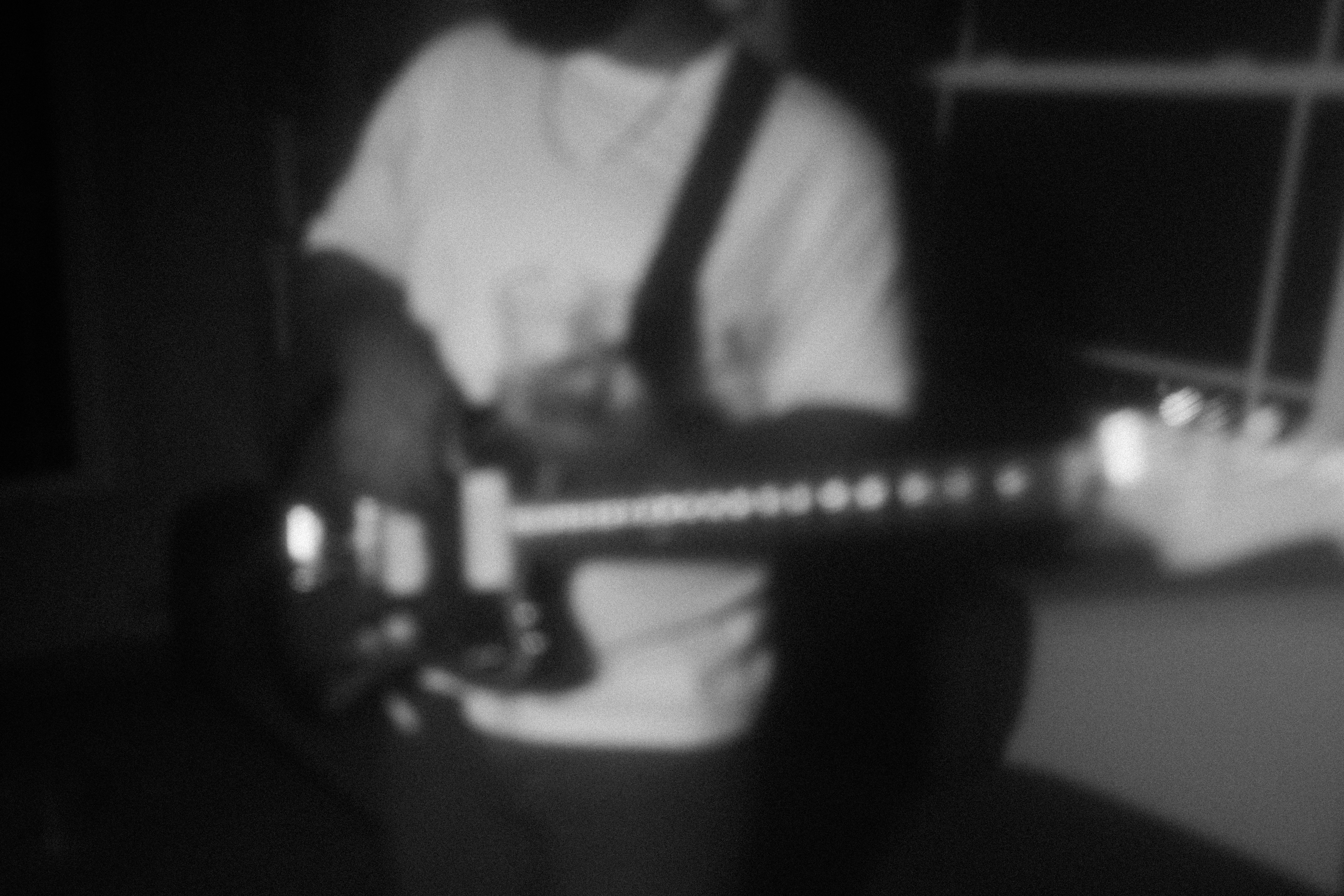 Neon Haze: A Silhouette with a Guitar in Low Light
