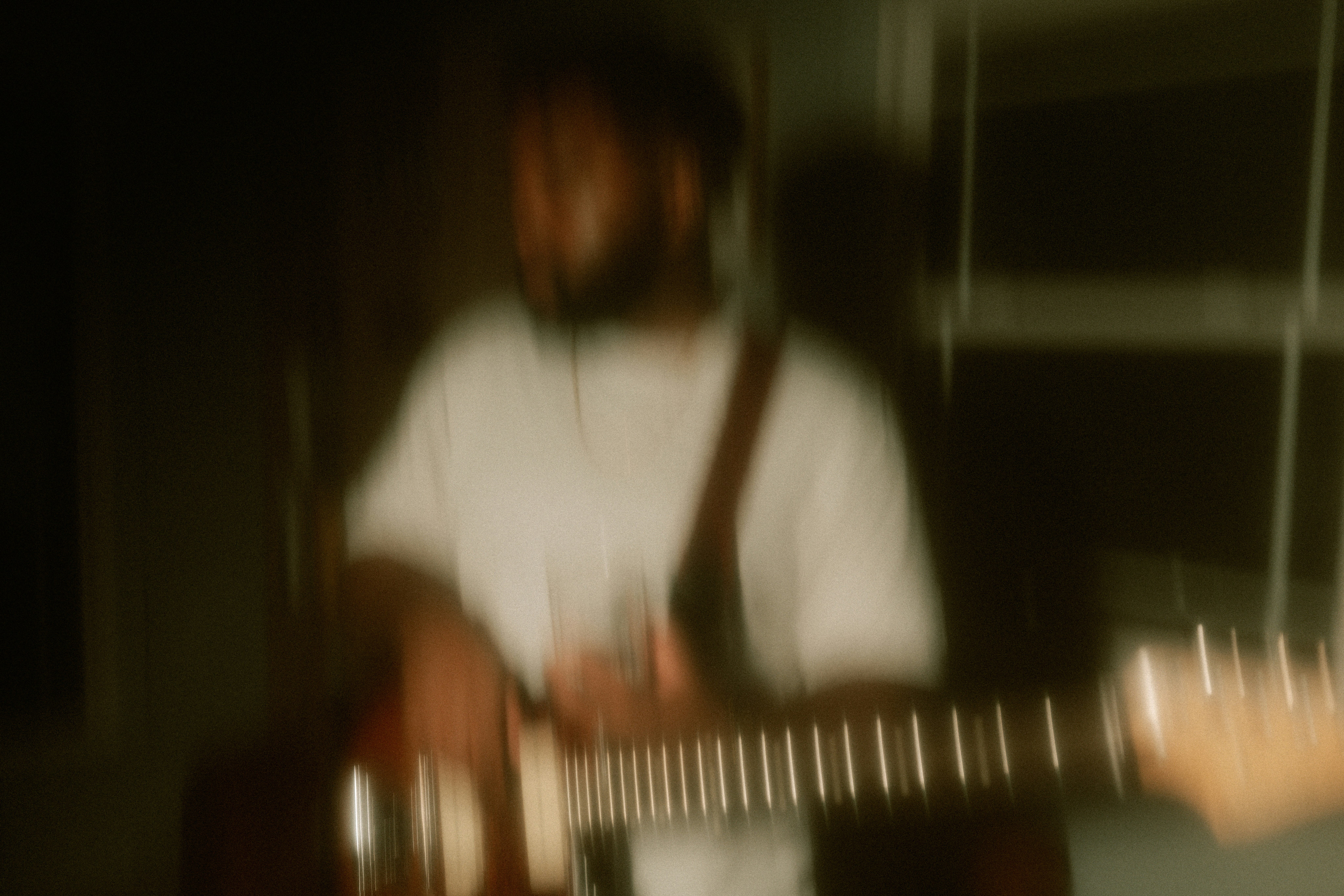 Hazy Street-Stage Serenade: A Guitarist in Low Light