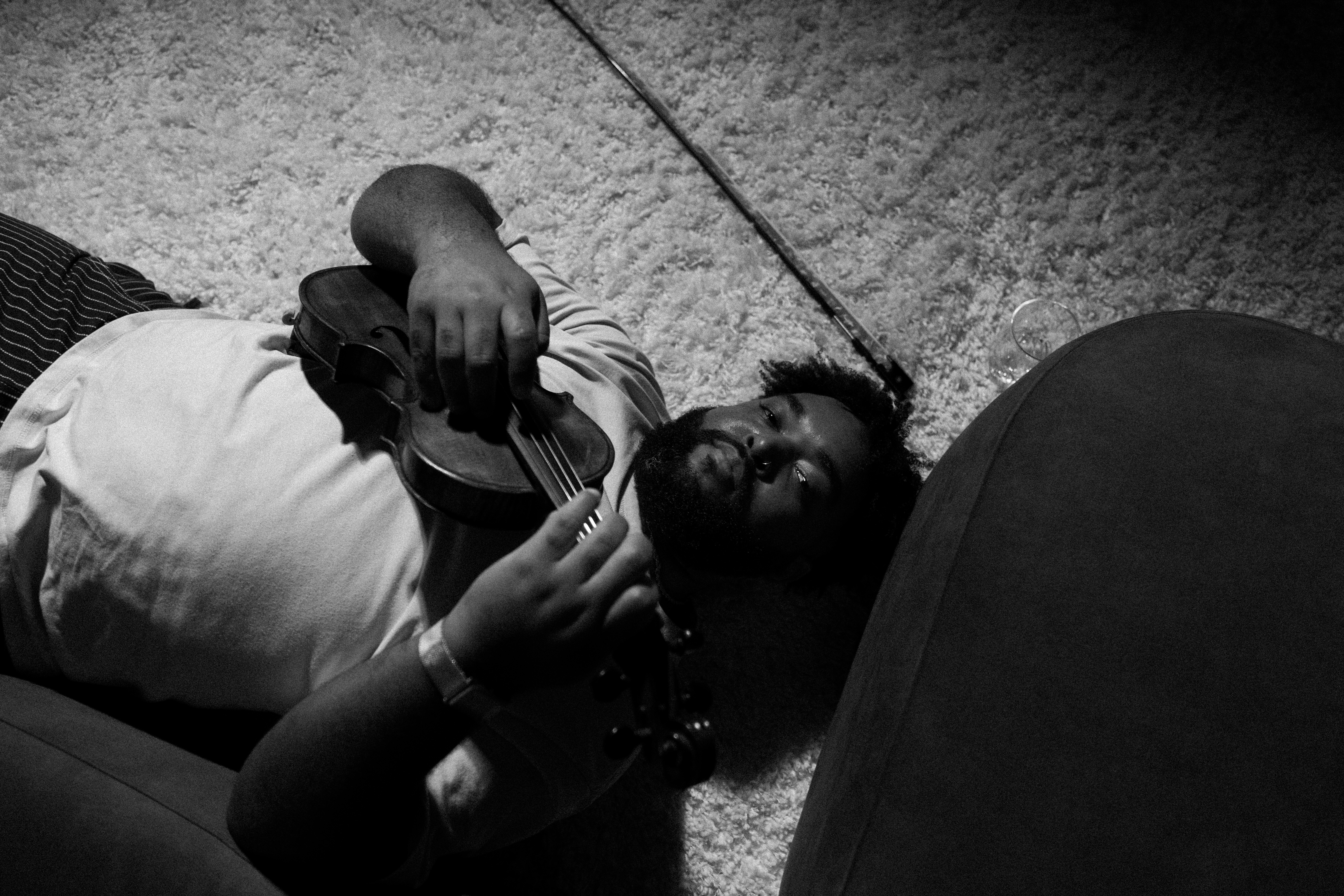 Midnight Serenade: A man lounging with a guitar in grayscale