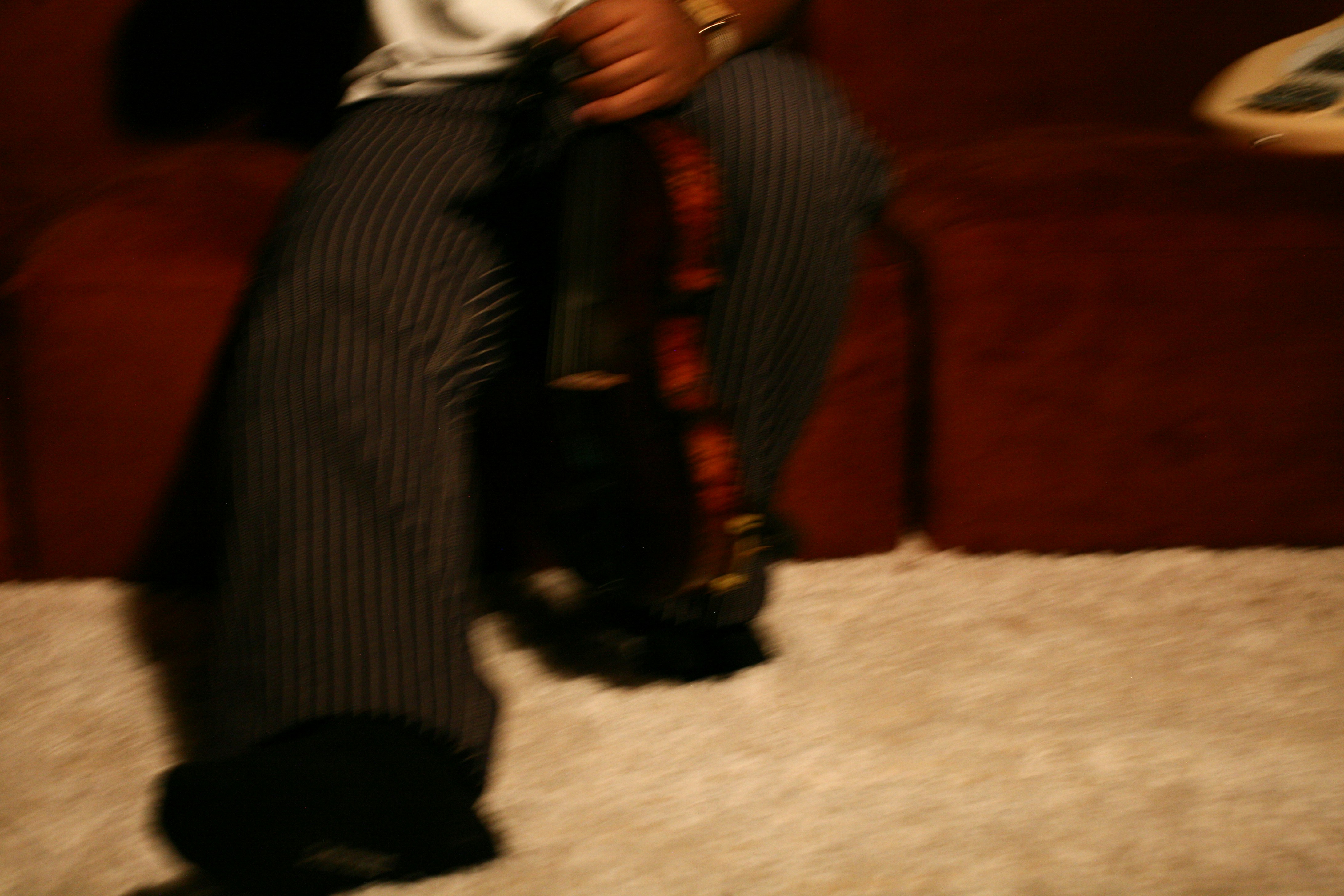 Blurred Presence: A Person Resting with a Guitar by a Plush Rug