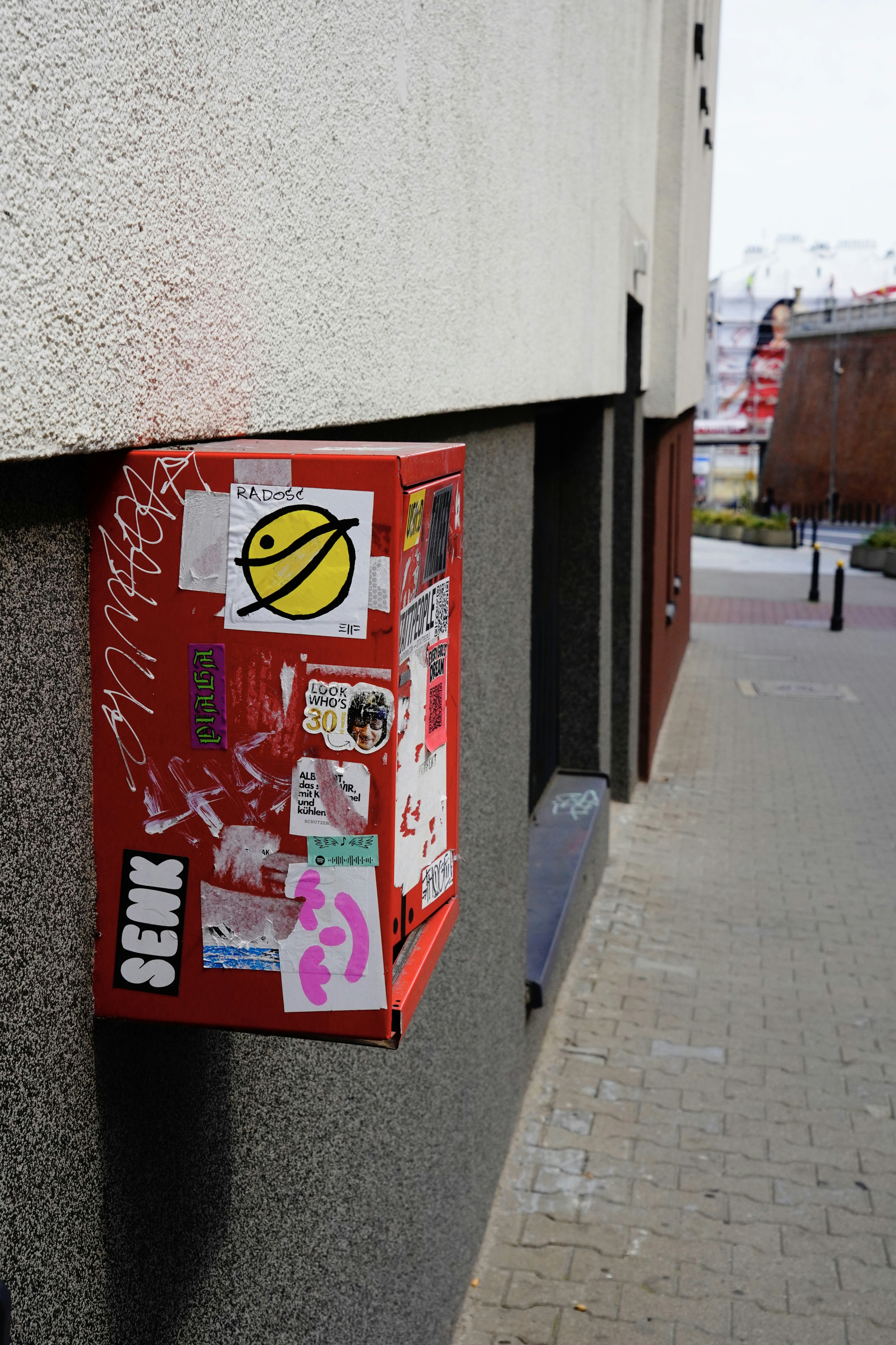 Red Newsstand on a City Wall, Streaks of Street Graffiti