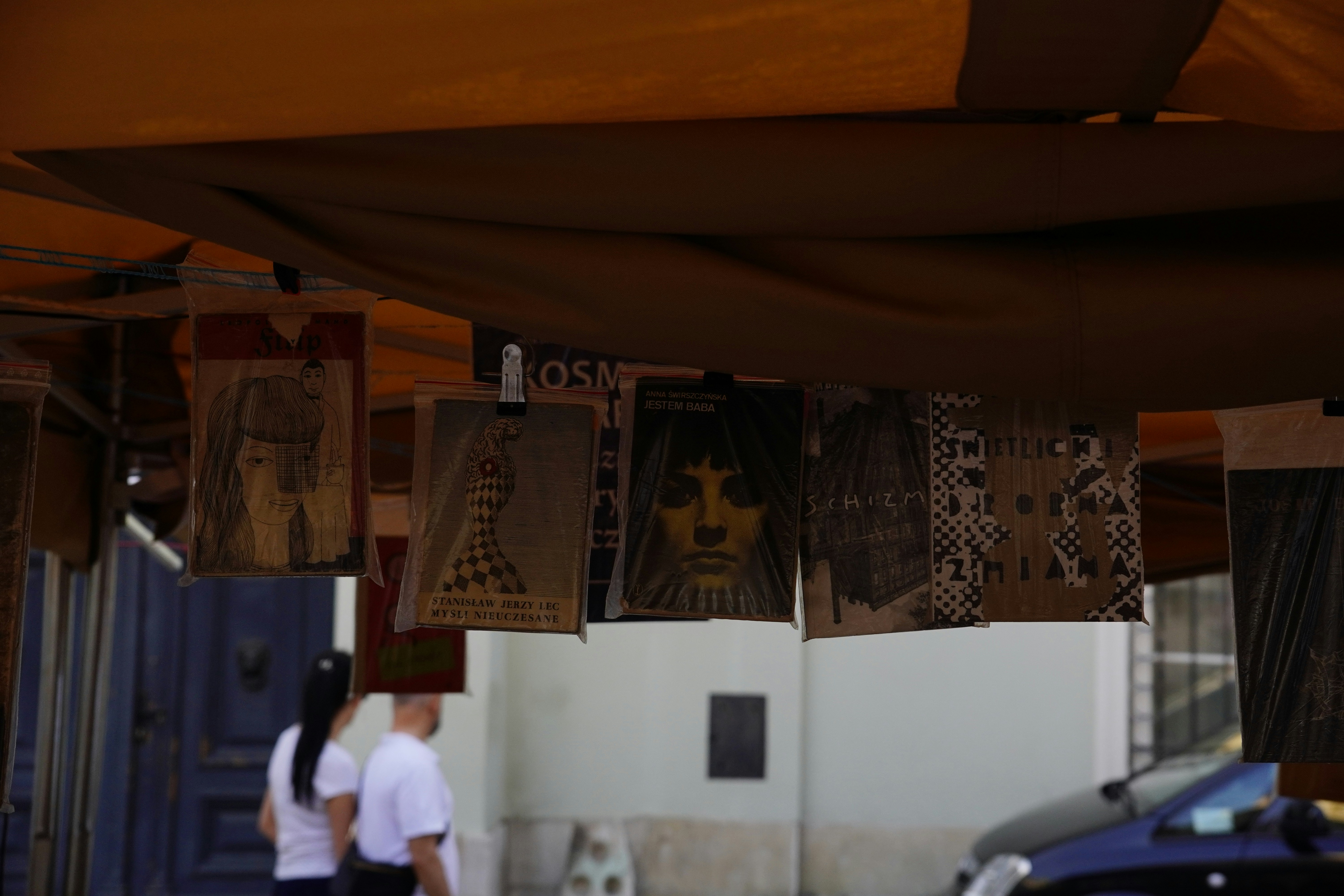Hanging Portraits Under a Tented Stall