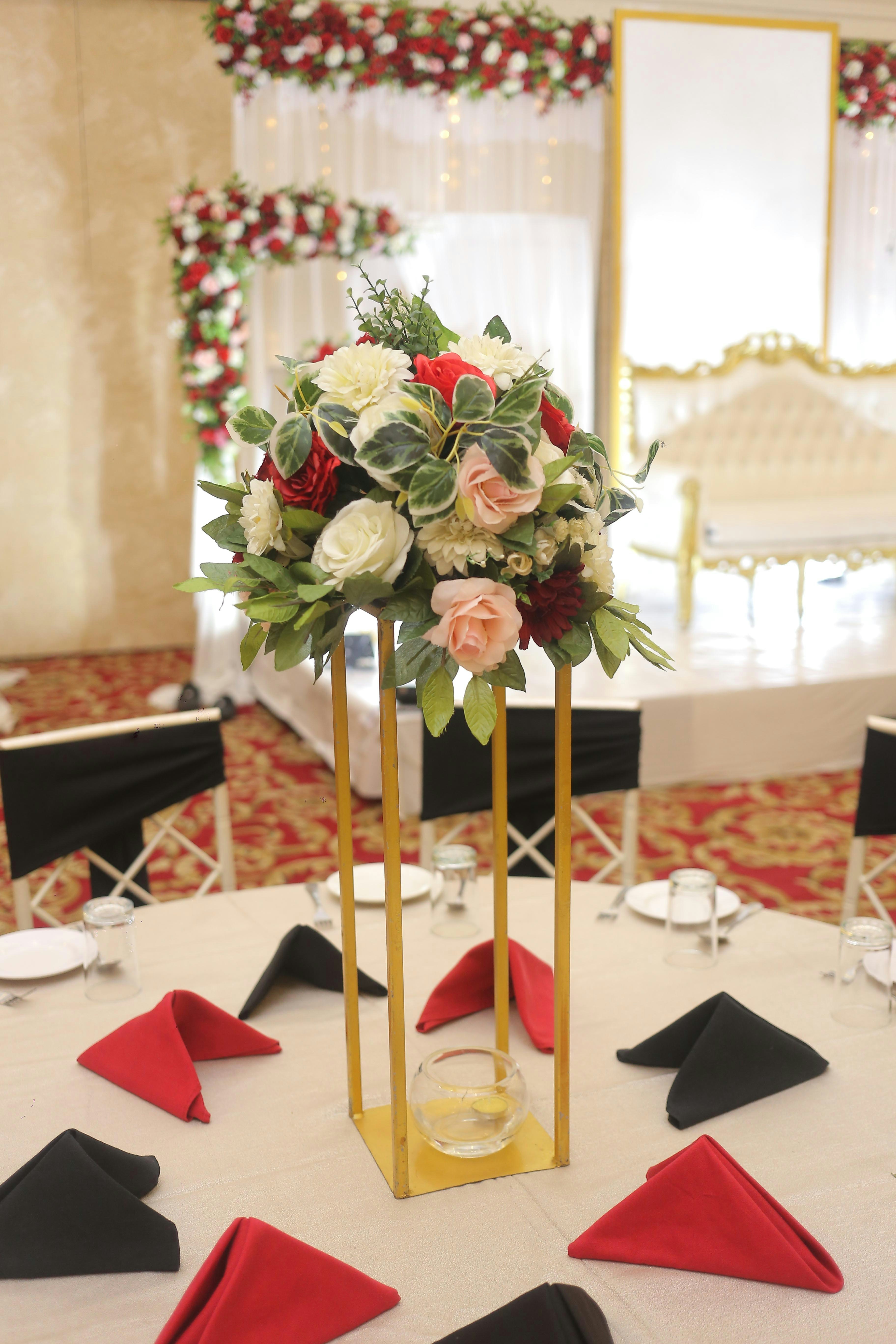 Tall Floral Centerpiece Rising Above a Round Dining Table