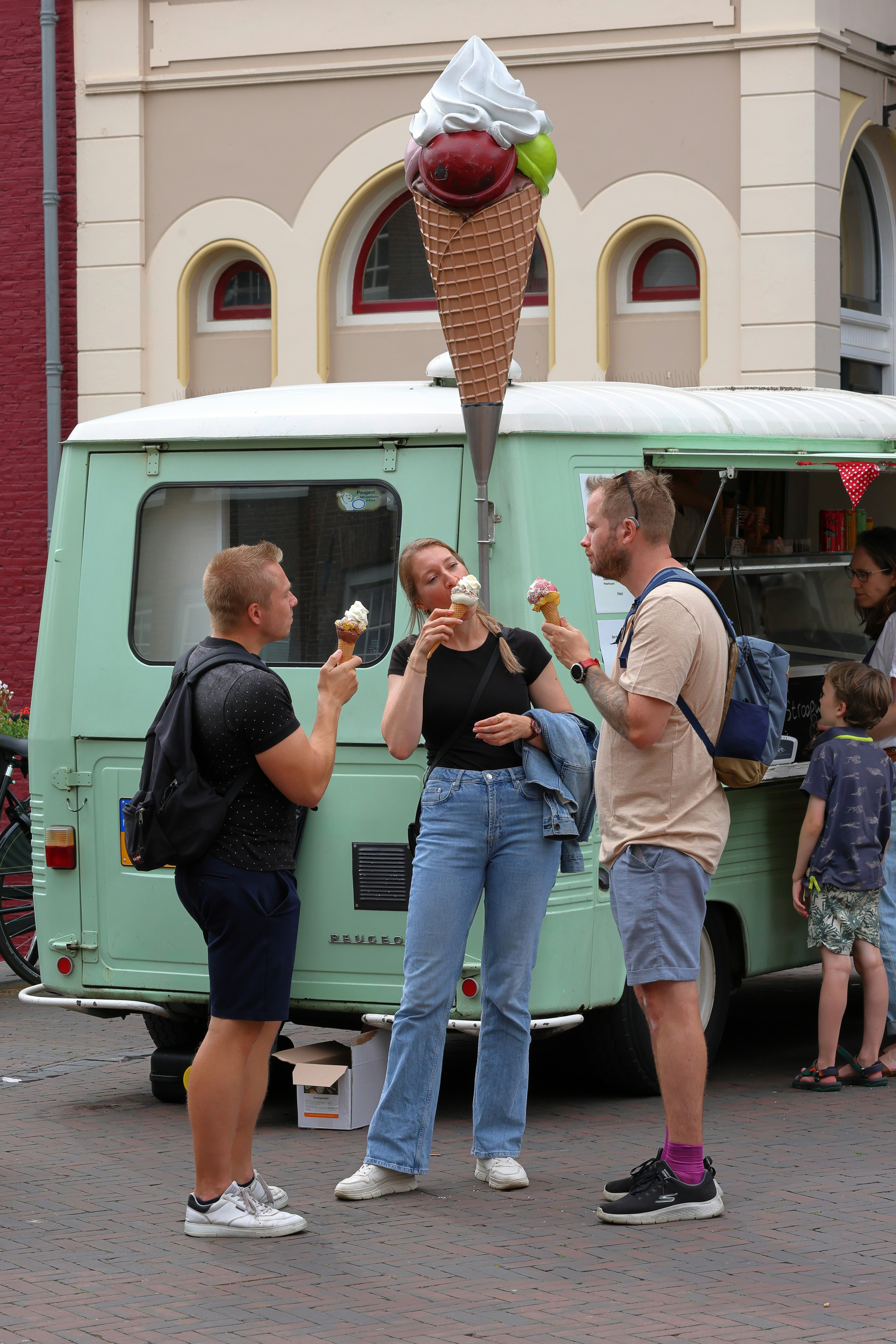 Ice Cream Convergence: Friends Gather Under a Giant Cone