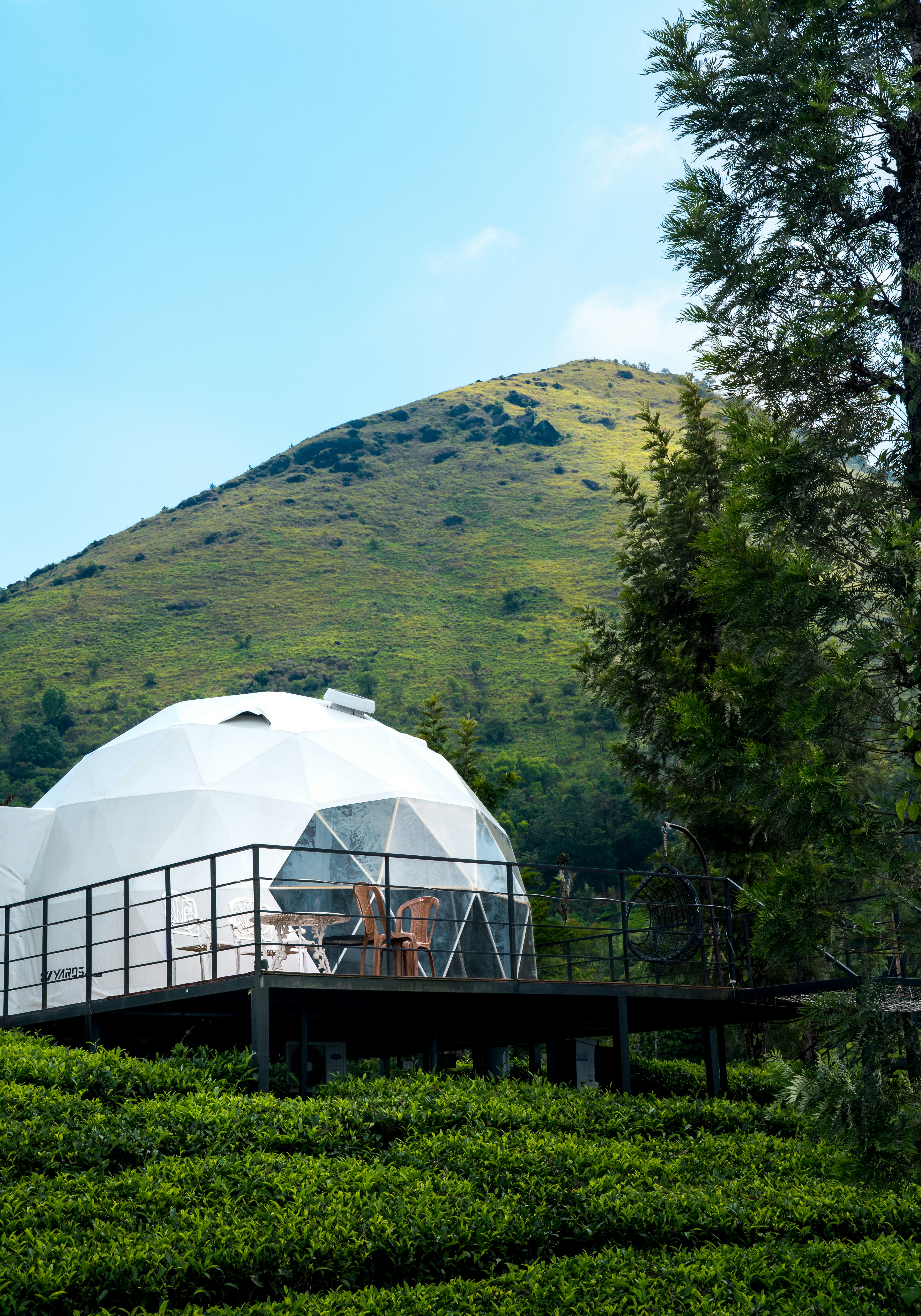 Geodesic Dome Terrace Amid Rolling Green Slopes