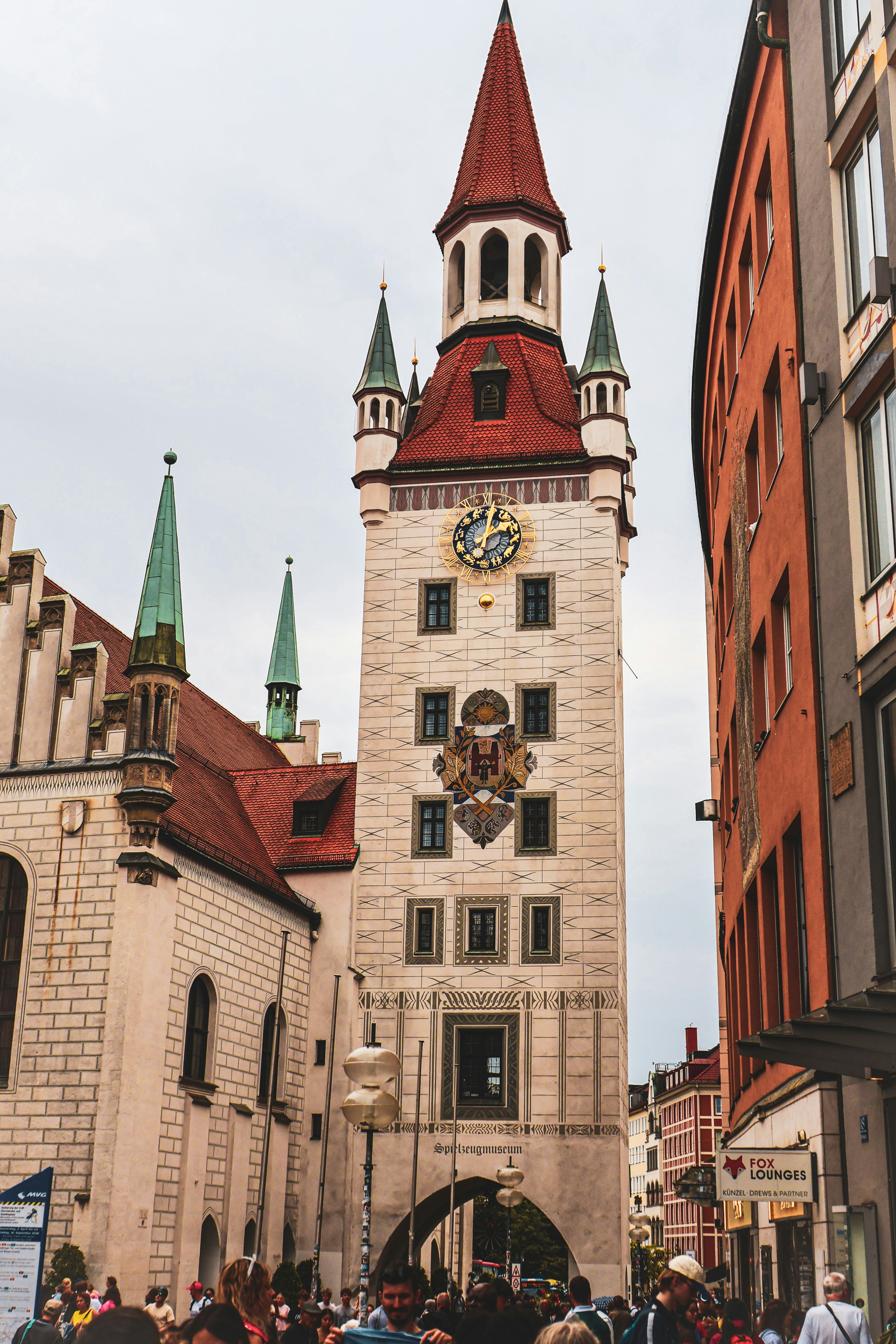 Tower of Time: The Clock Tower Greeted by a Courtyard of Travelers