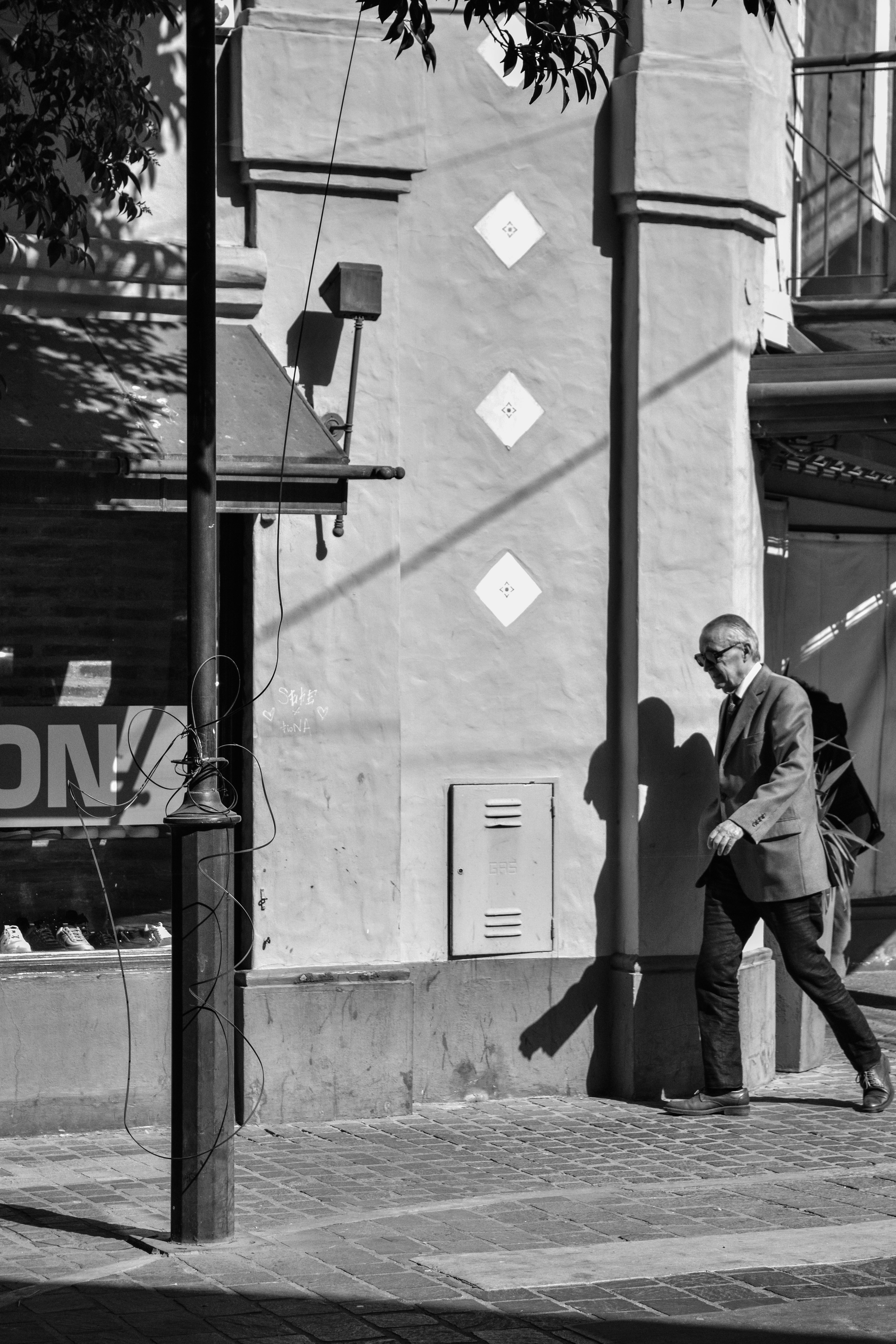 Urban Portrait in Black and White: A Gait of Quiet Dignity