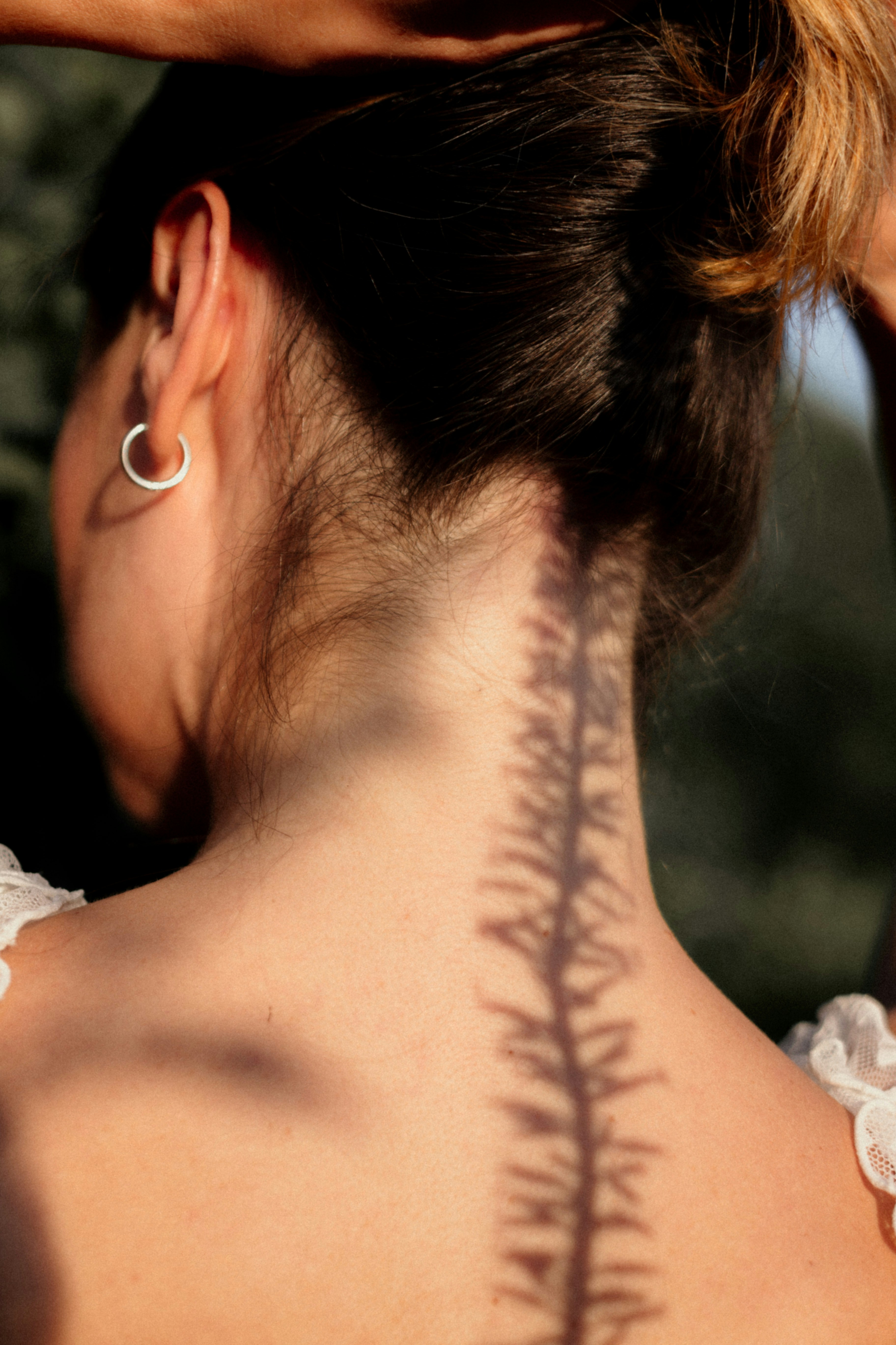 Shadowed Neckline: A Tattoo's Silent Rhythm