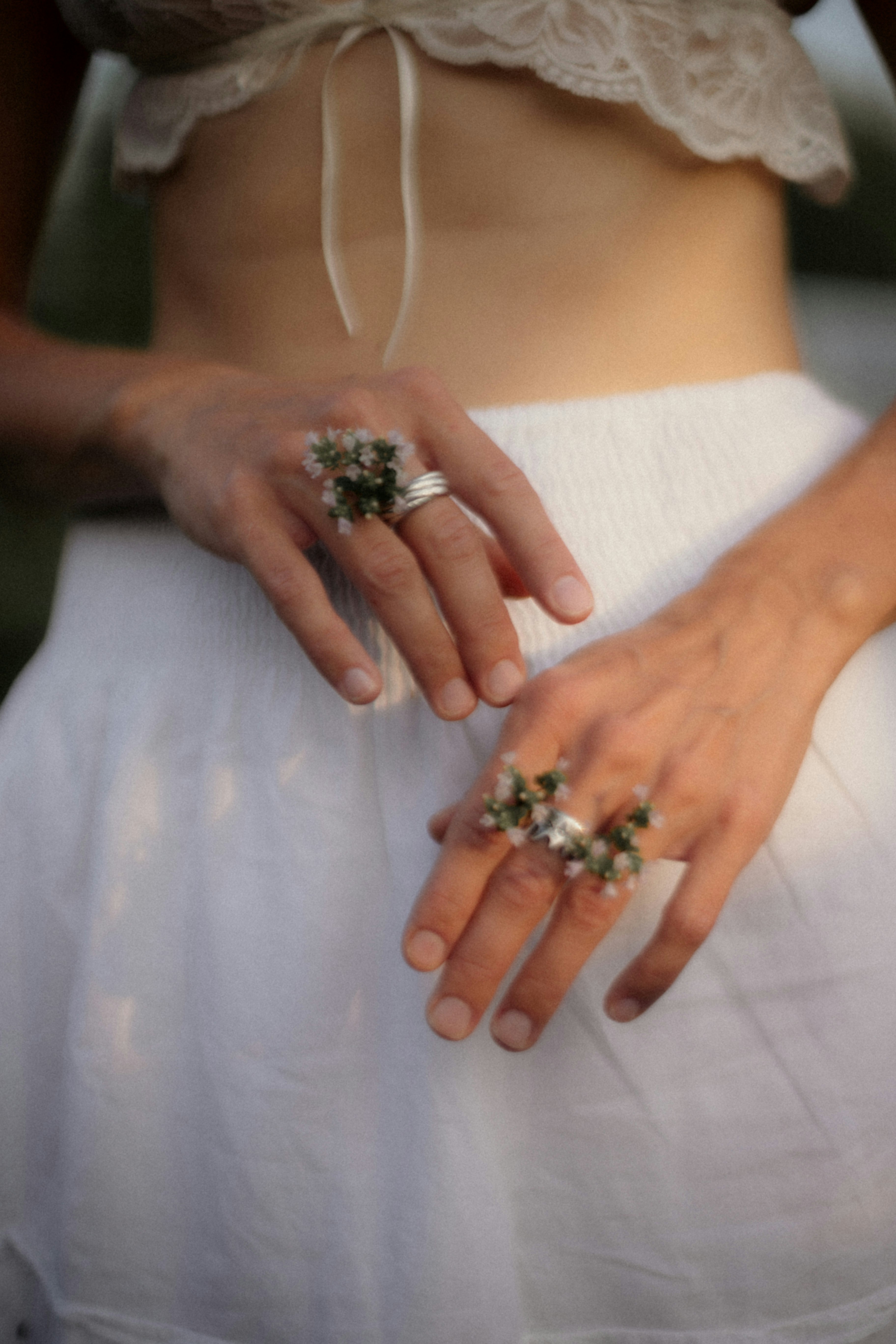 Barefoot in White: Hands with Floral Rings
