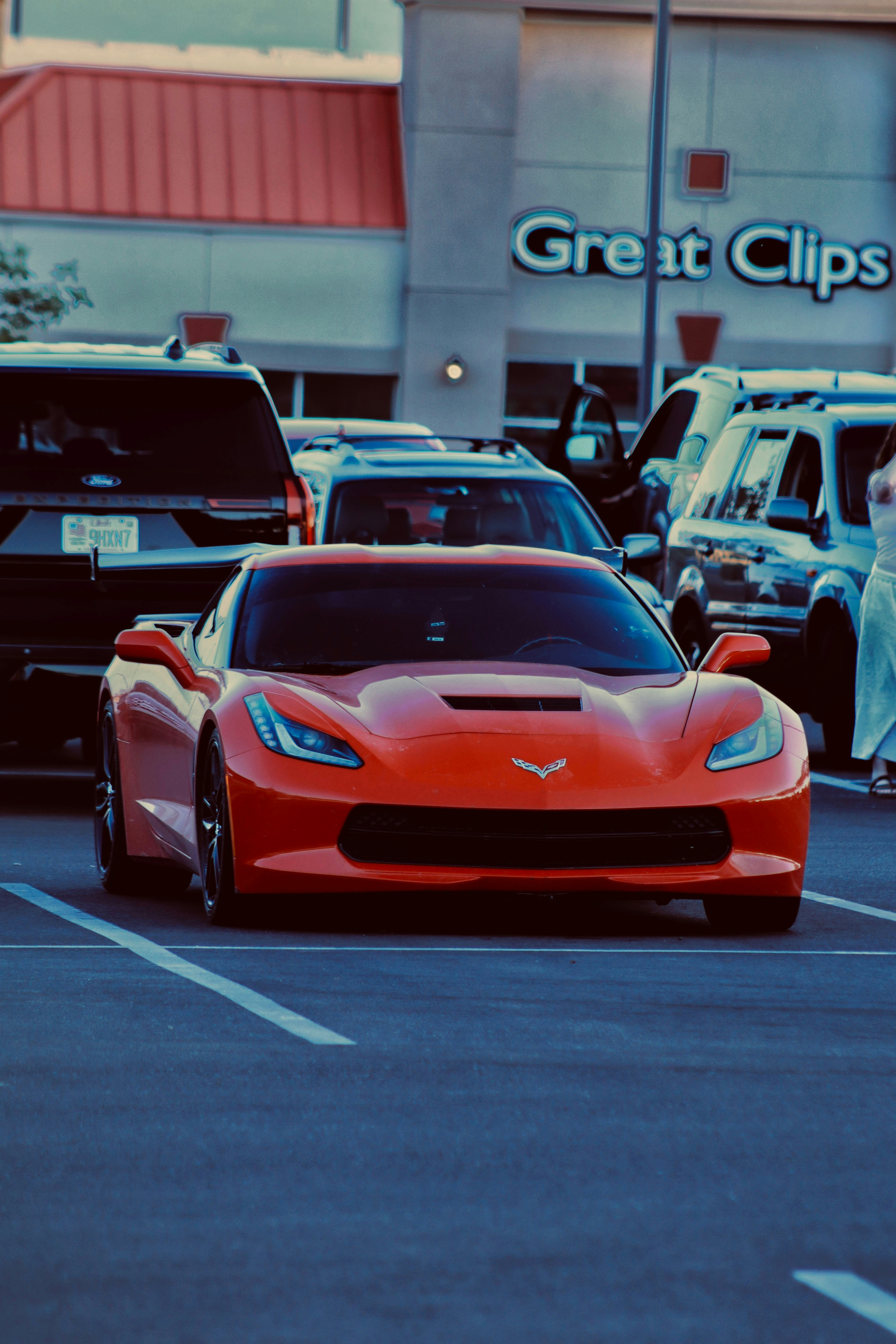 Citrus Allure: The Red Corvette Reigns in a Busy Lot
