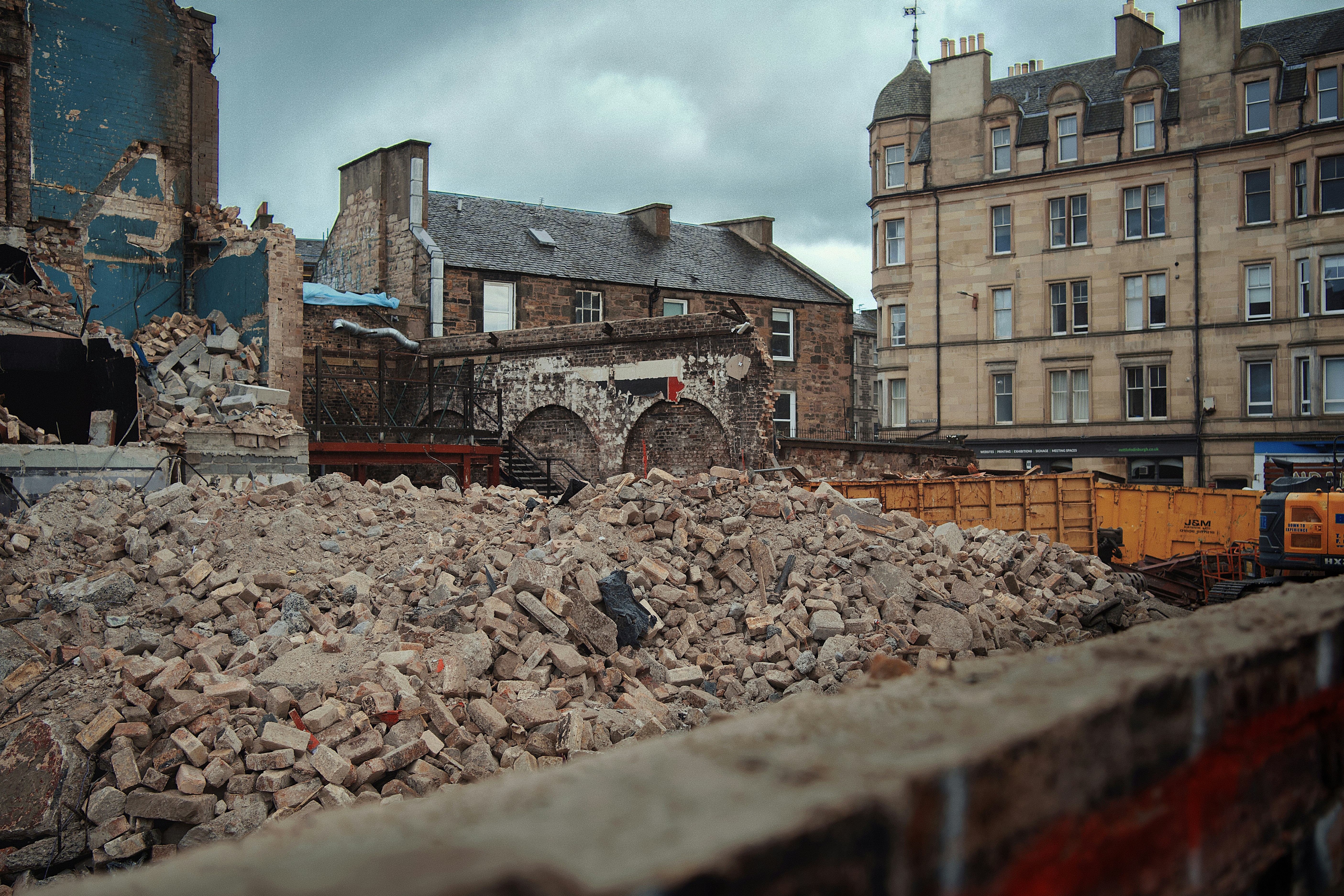 Rubble and remnants: urban construction site beneath a weathered cityscape
