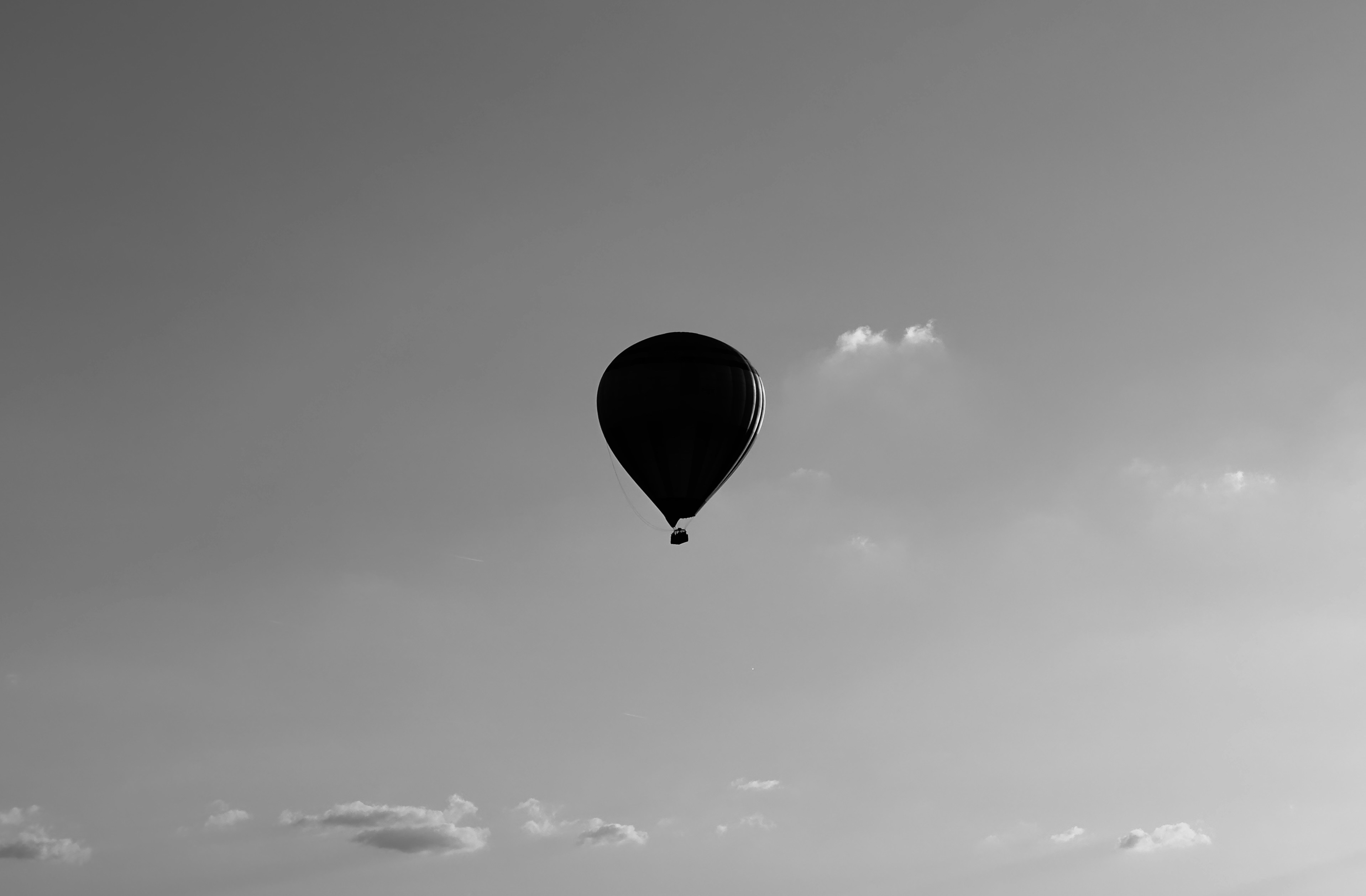Floating Silence: A Lone Balloon Drifts Above a Calm Sky