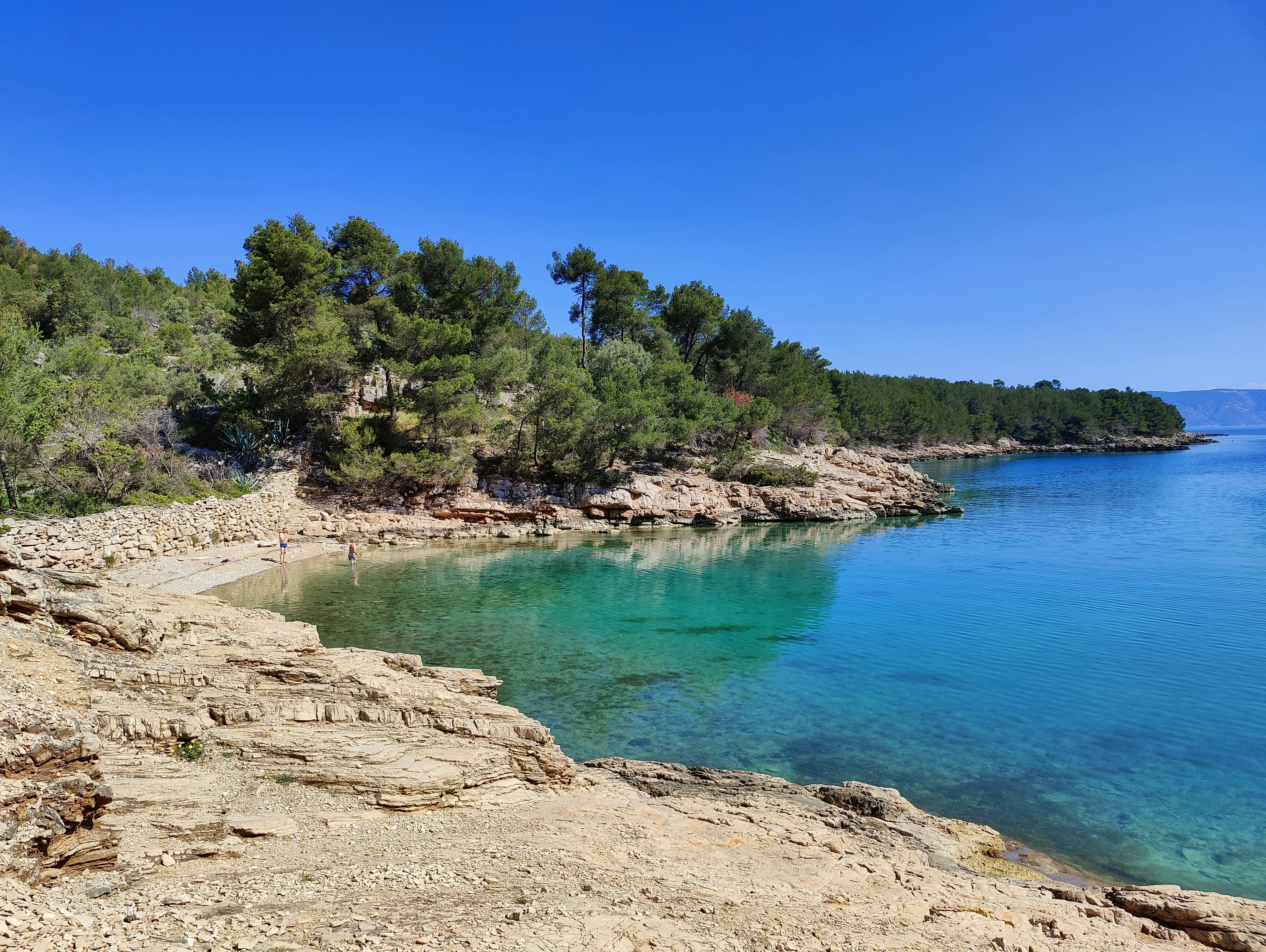 Emerald Cove with Rocky shoreline under a Clear Riviera Sky