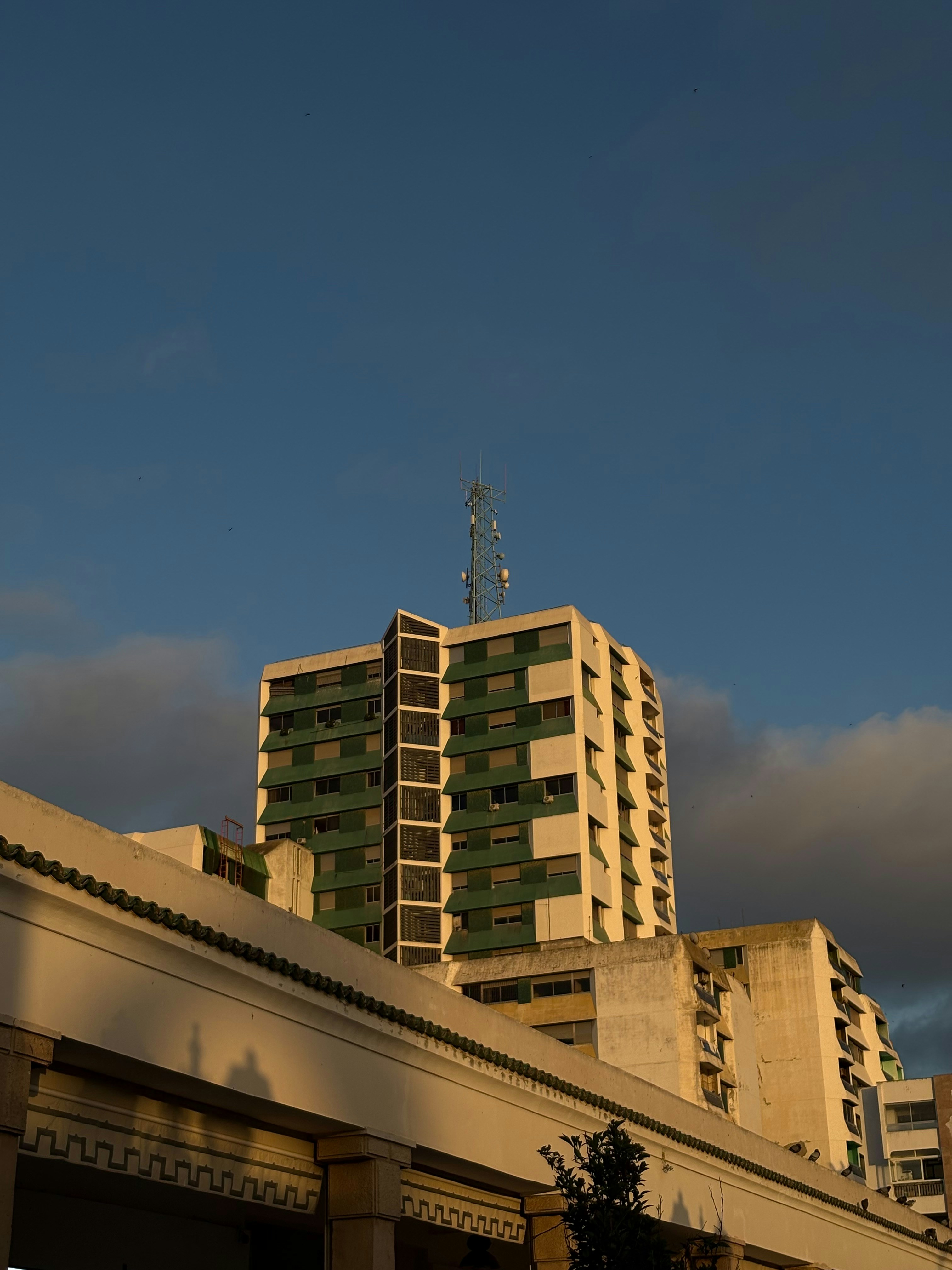 Sunlit High-Race: A Tower Silhouette Under a Clear Evening Sky