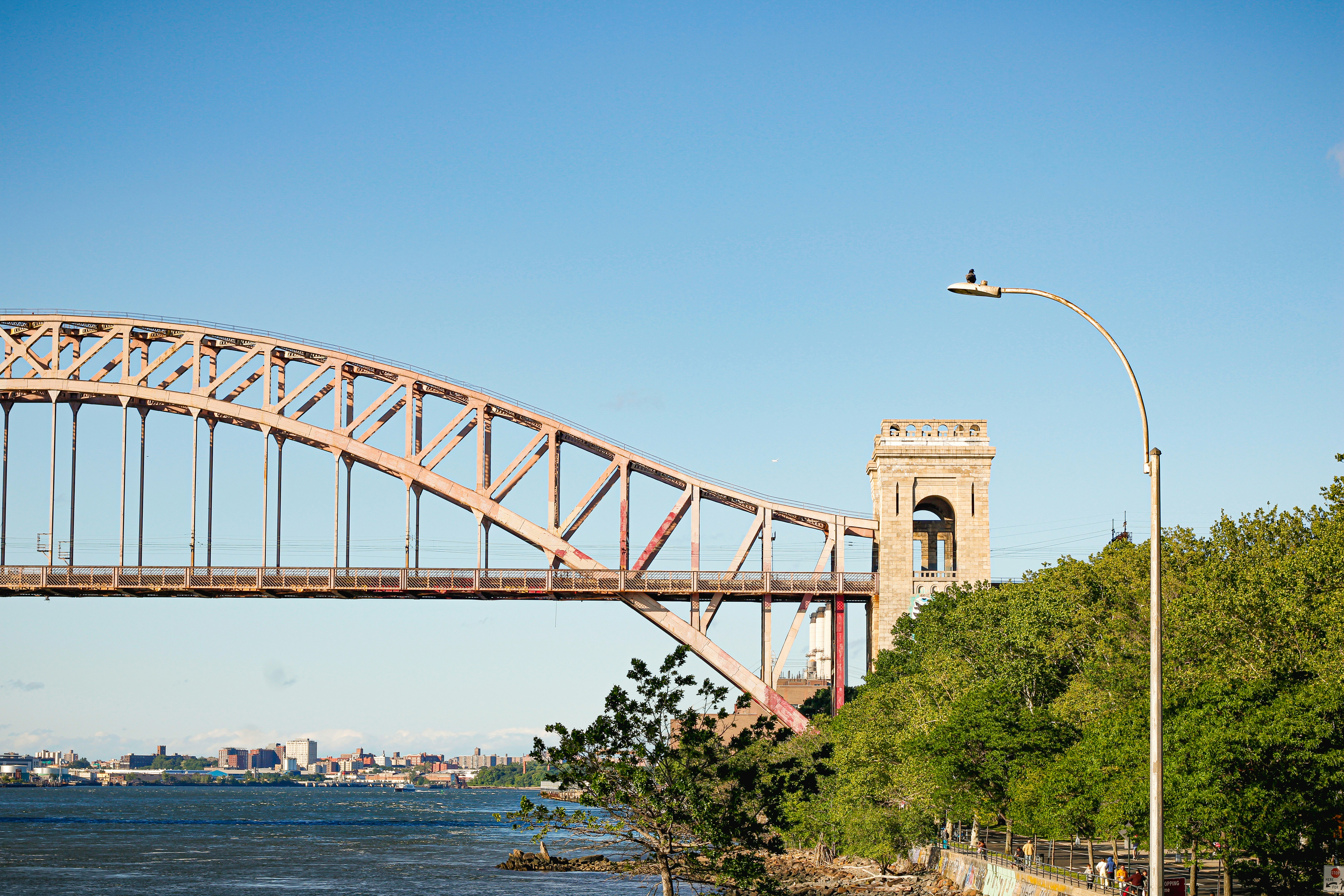 Rivertown Span: a steel-arch silhouette over a calm inlet
