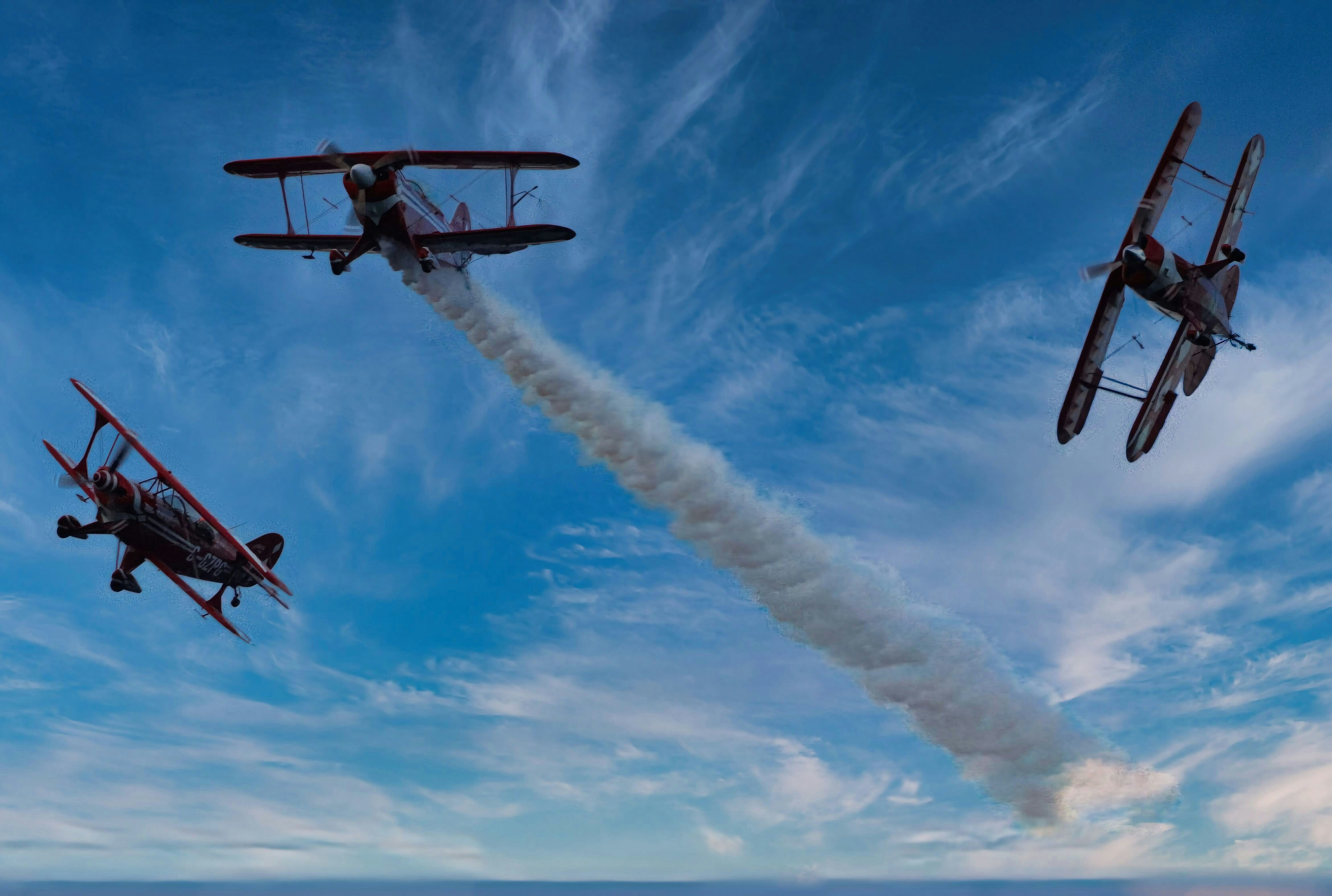 Winged Vistas: Tri-Plane Aerial Dance Across a Cerulean Sky