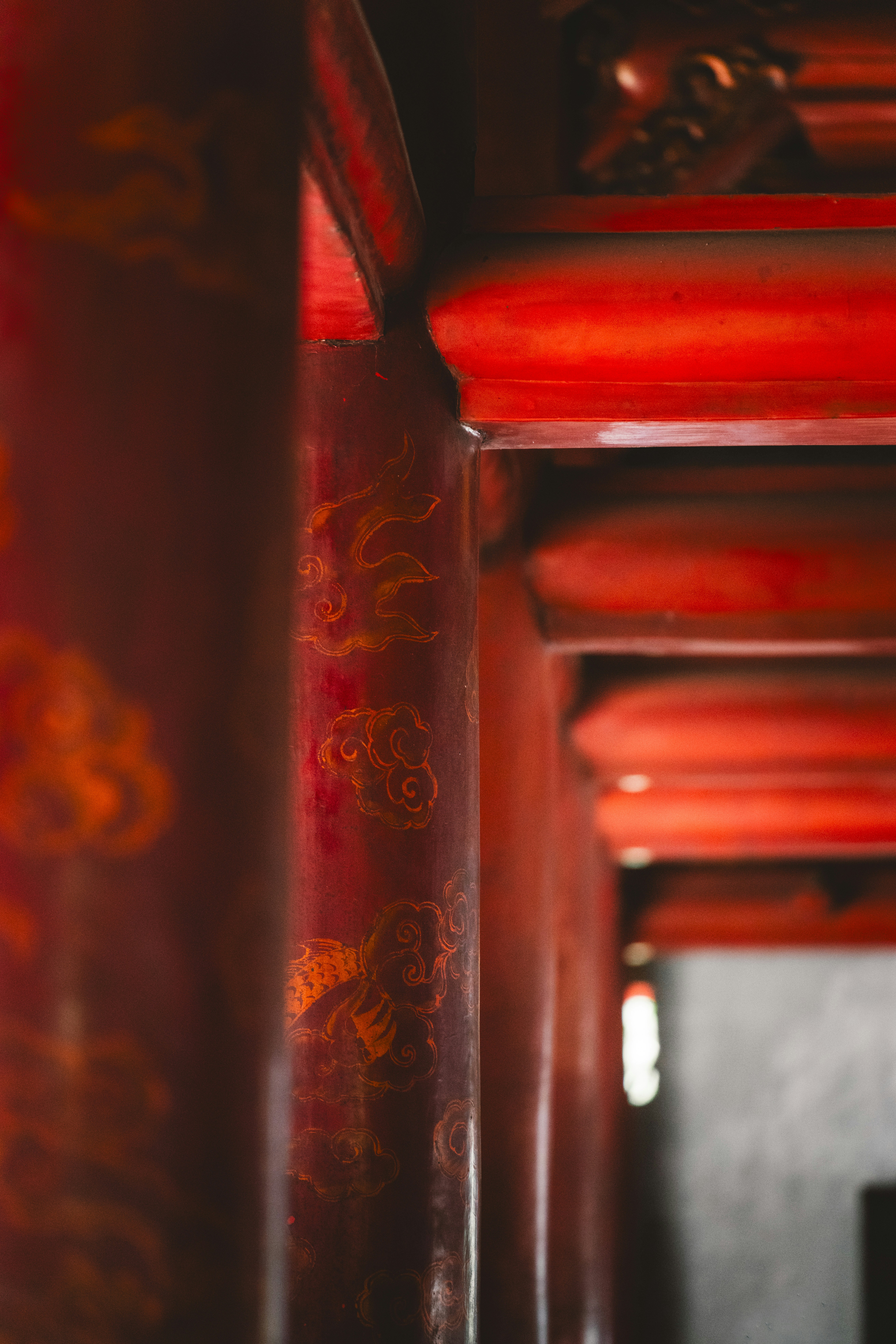 Crimson Corridor: Painted Pillars in a Red-Hued Passage