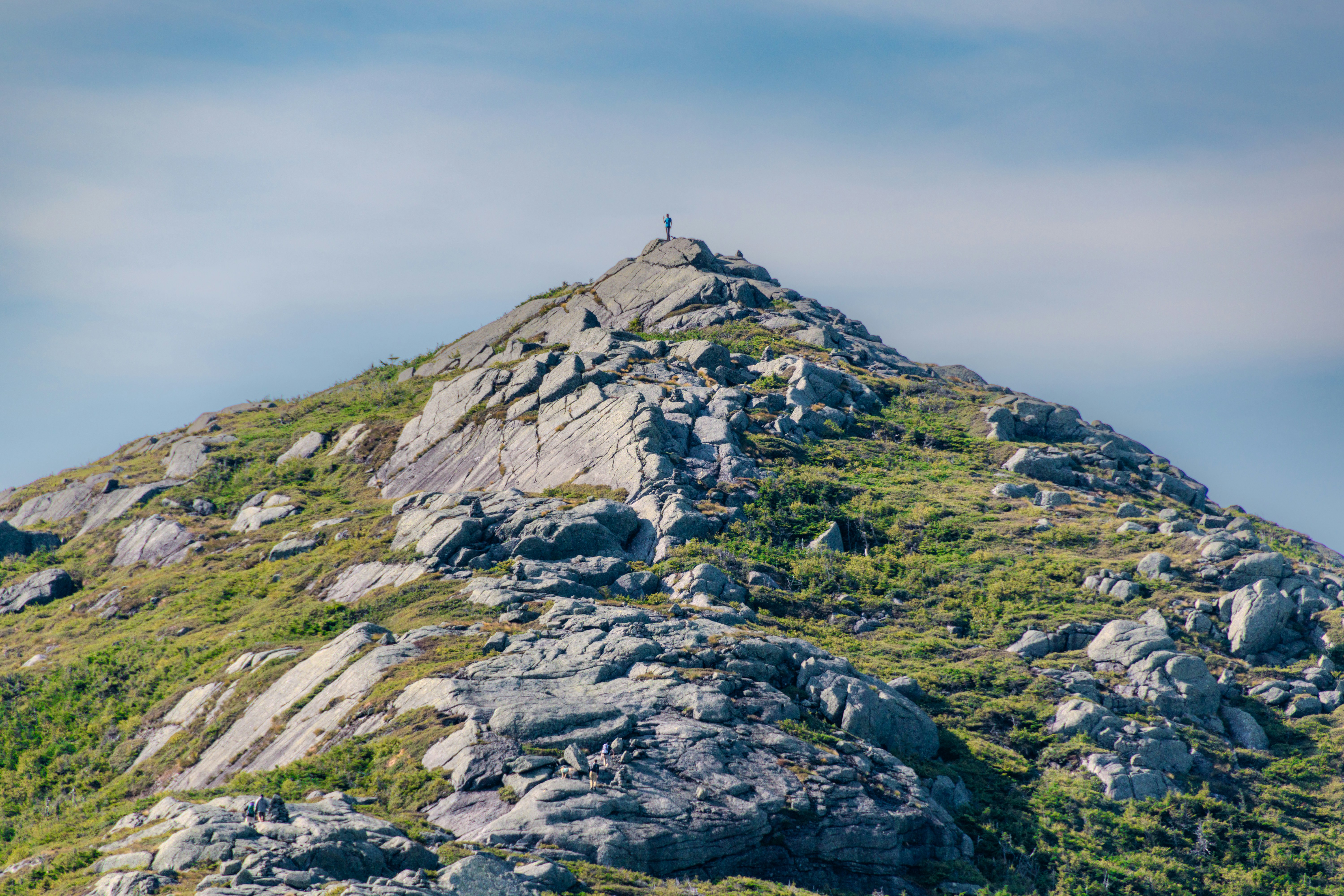 Summit Cross Silhouette: Rocky Peak with Gentlegreen Slopes
