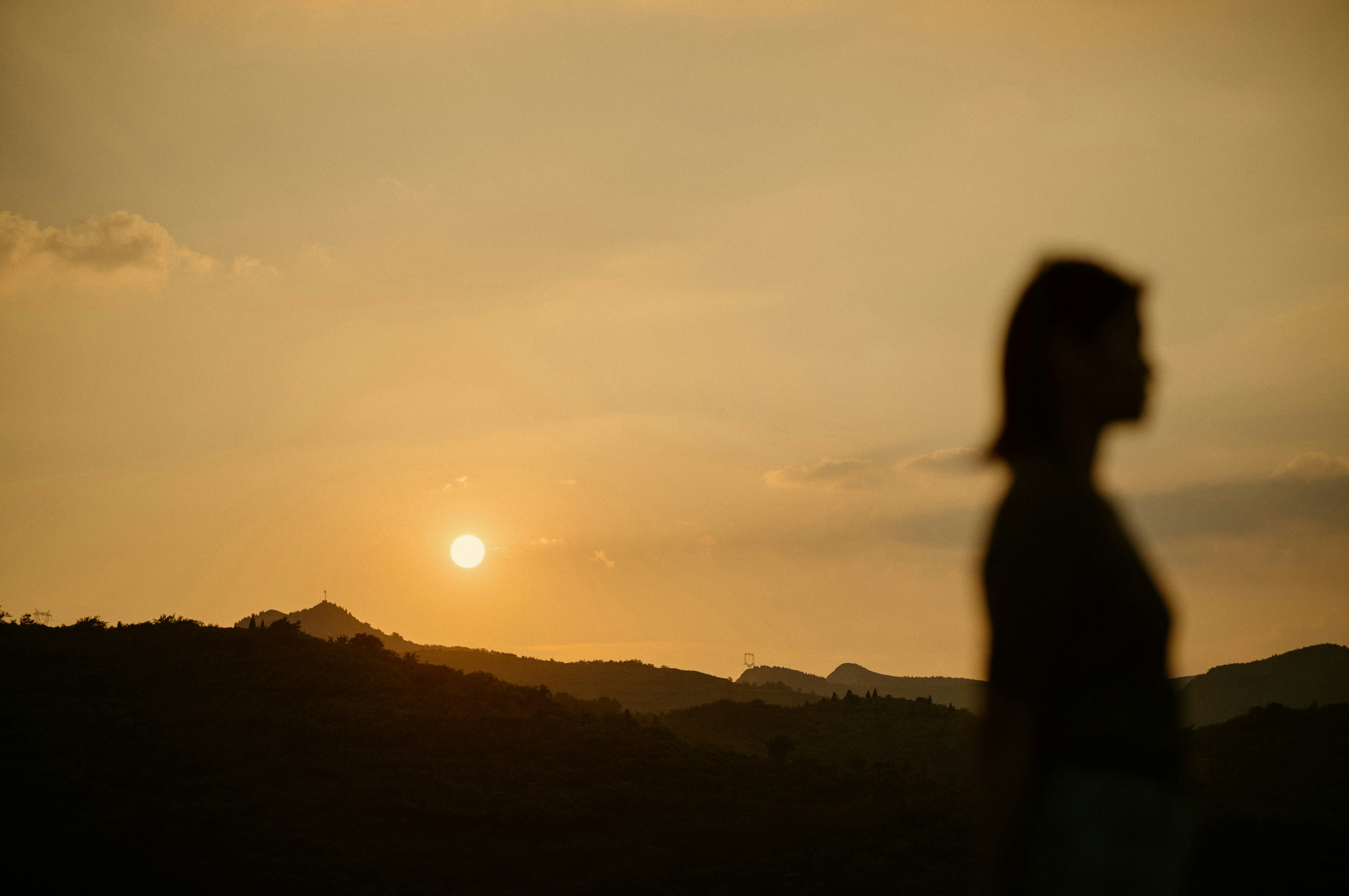 Silhouette at Sunset: A Quiet Moment Beyond the Horizon