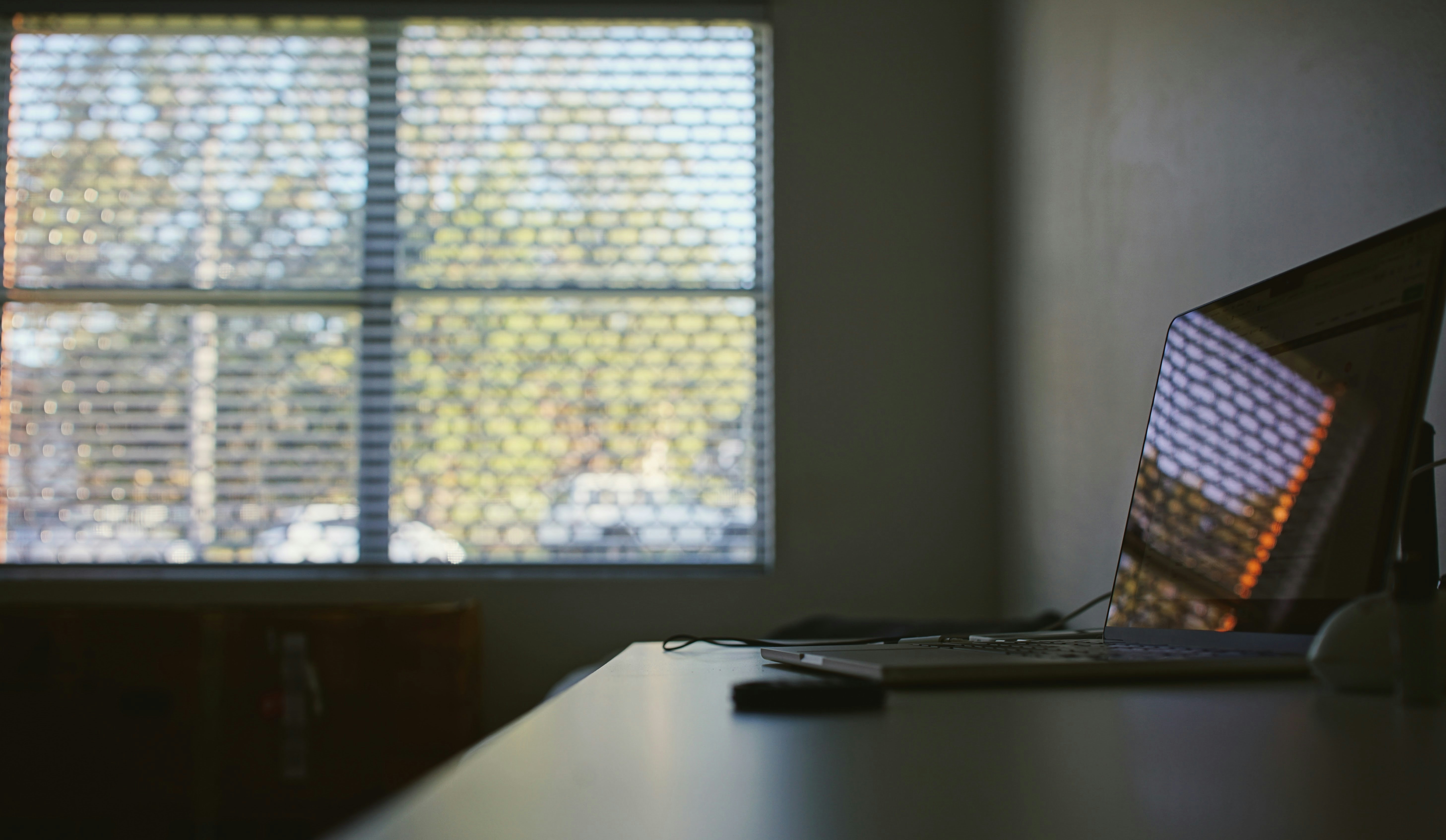 Quiet Workspace with Reflected Laptop Glow
