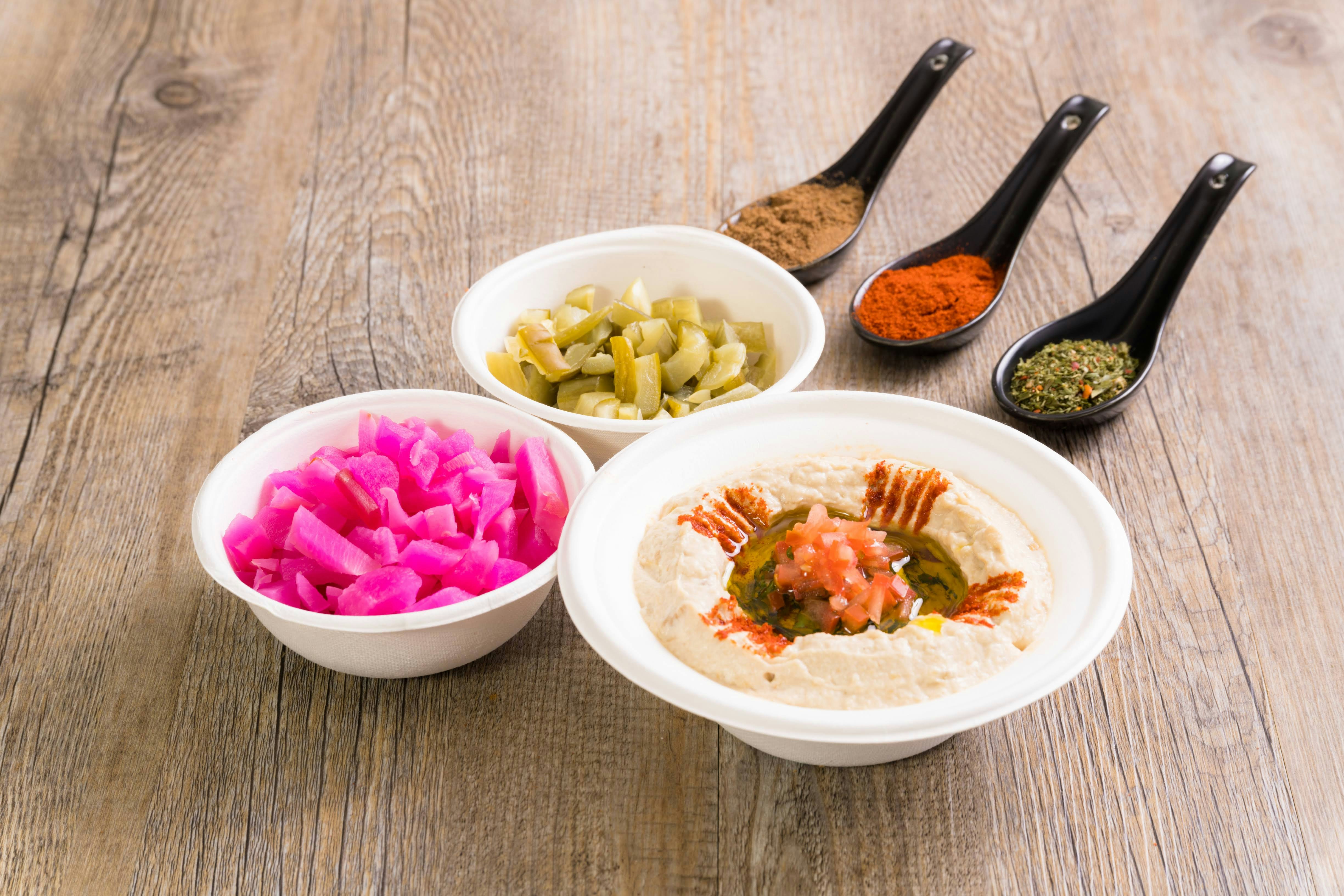 Colorful Mezze Trio in Ceramic Bowls on Weathered Wood