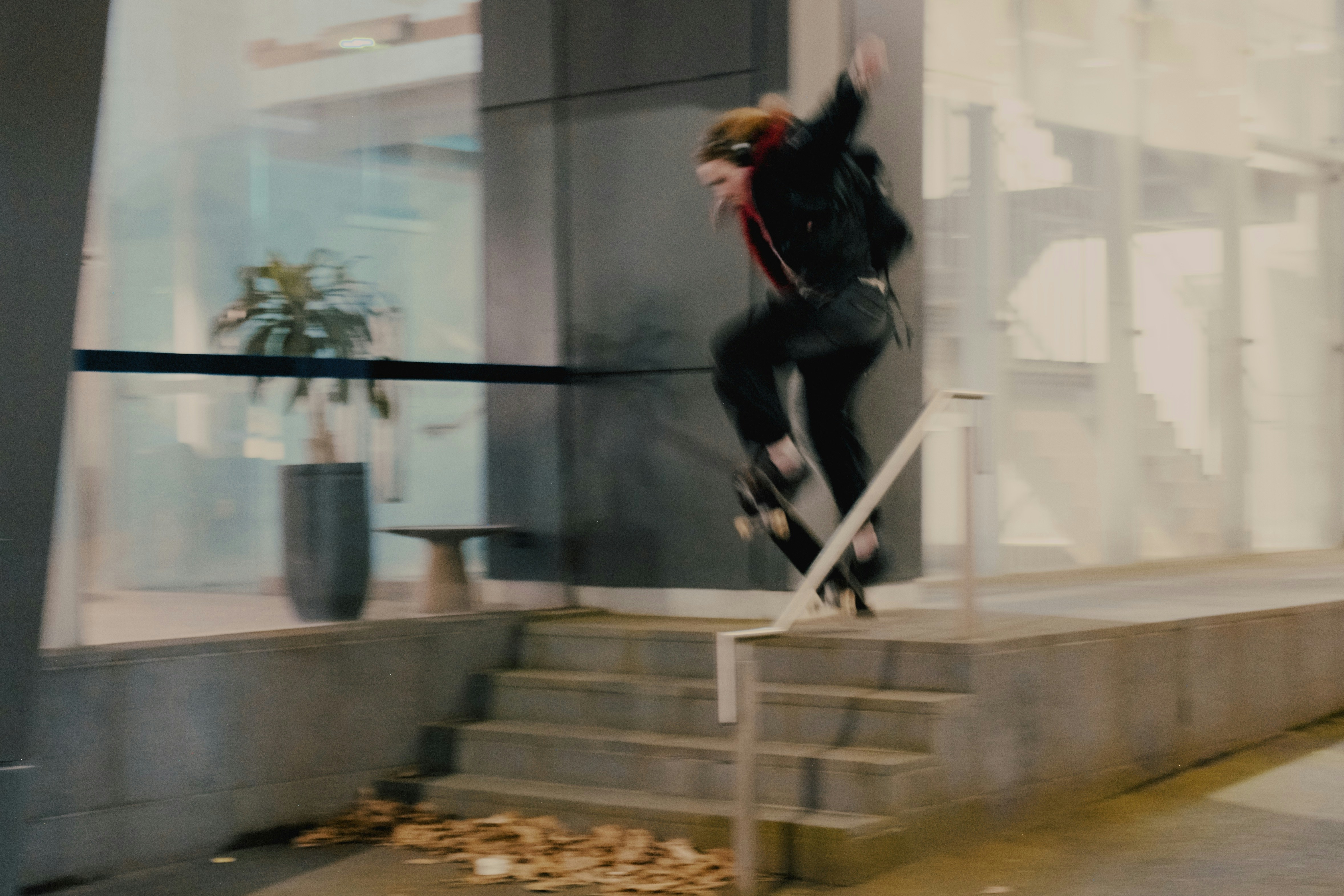 Skater in Mid-Flight: Street-Step Rush Across a Glassy Facade