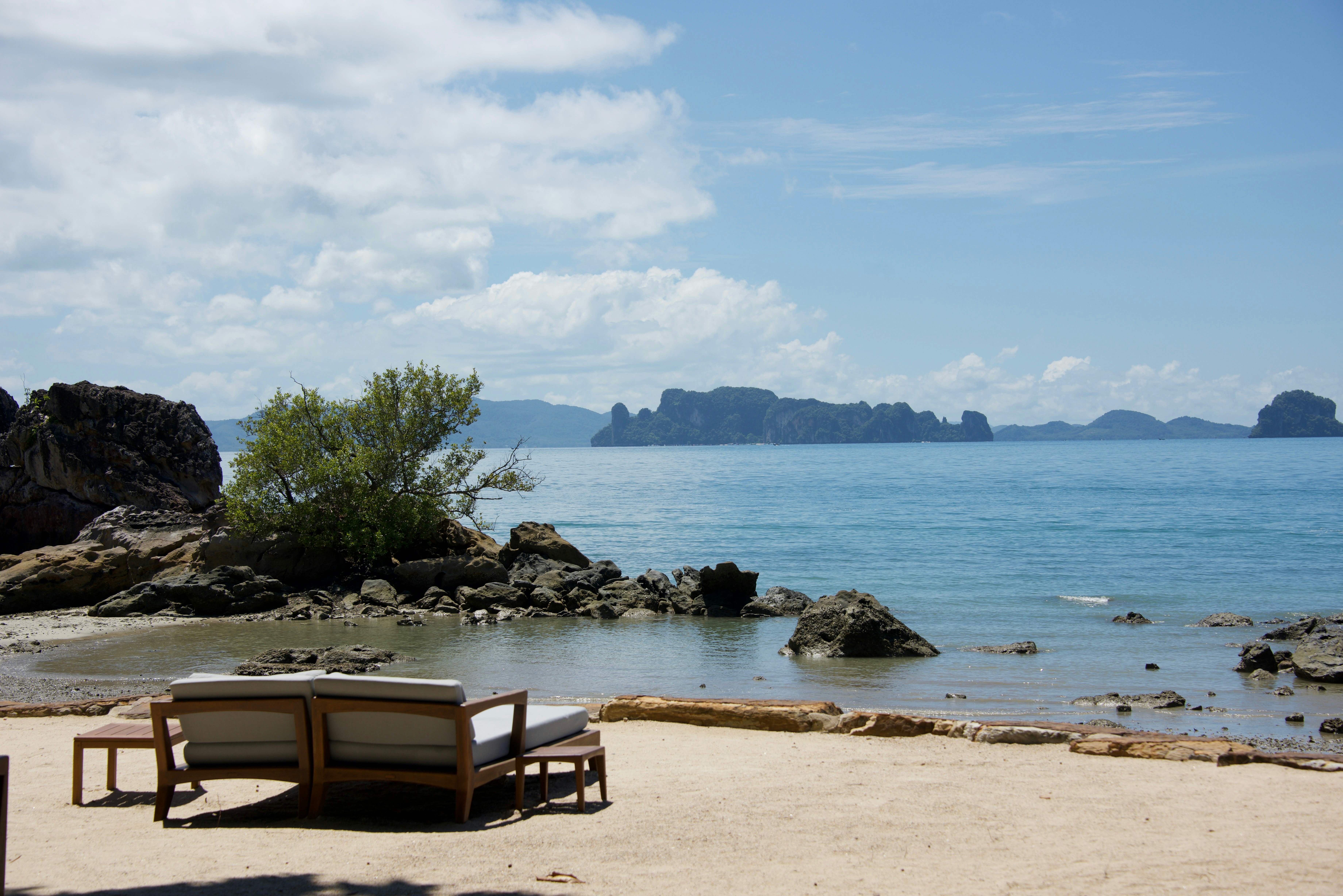Seating at the Sea's Edge under a Quiet Sky