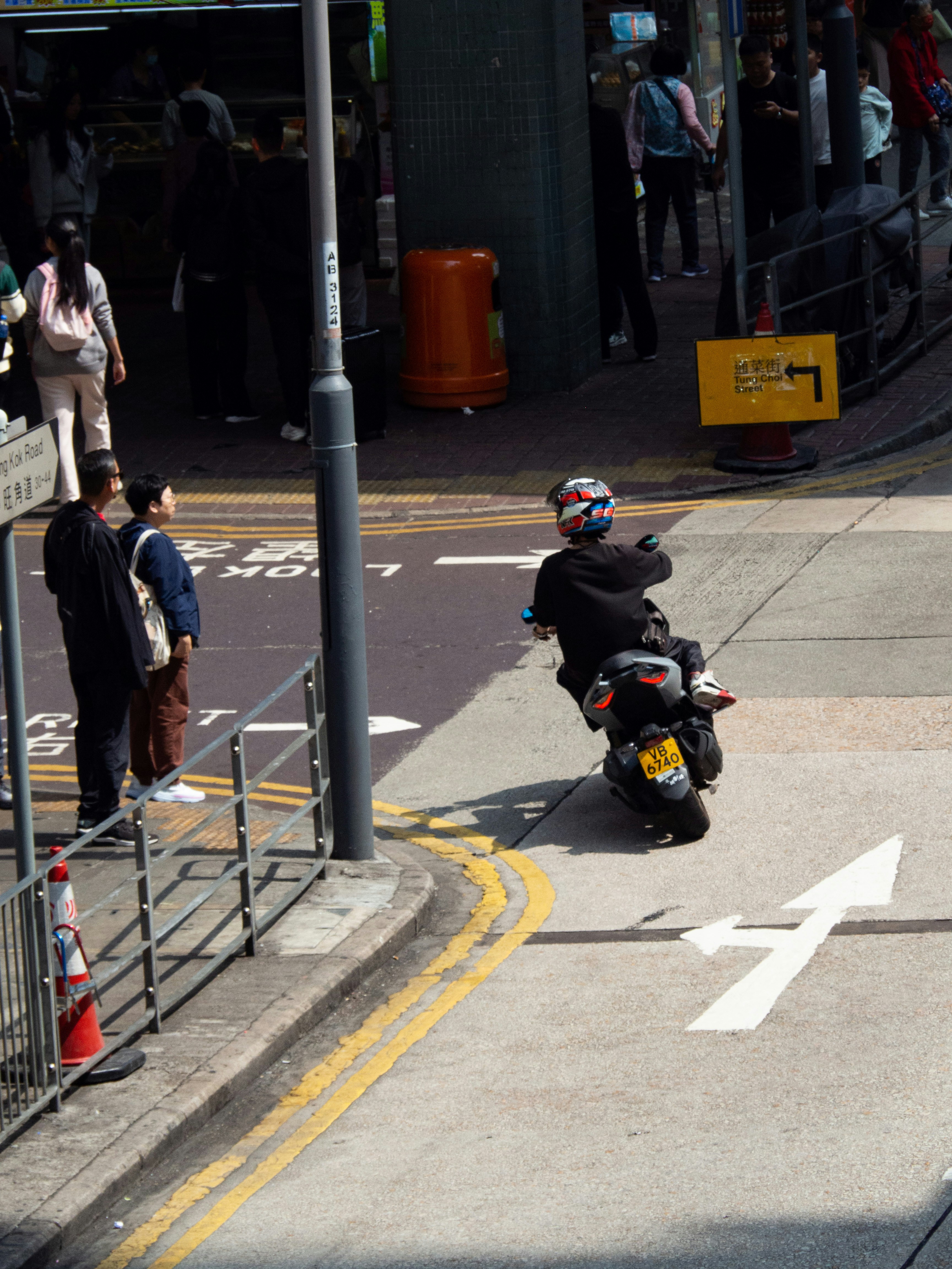 Motorcycle Rider at a Busy Urban Corner