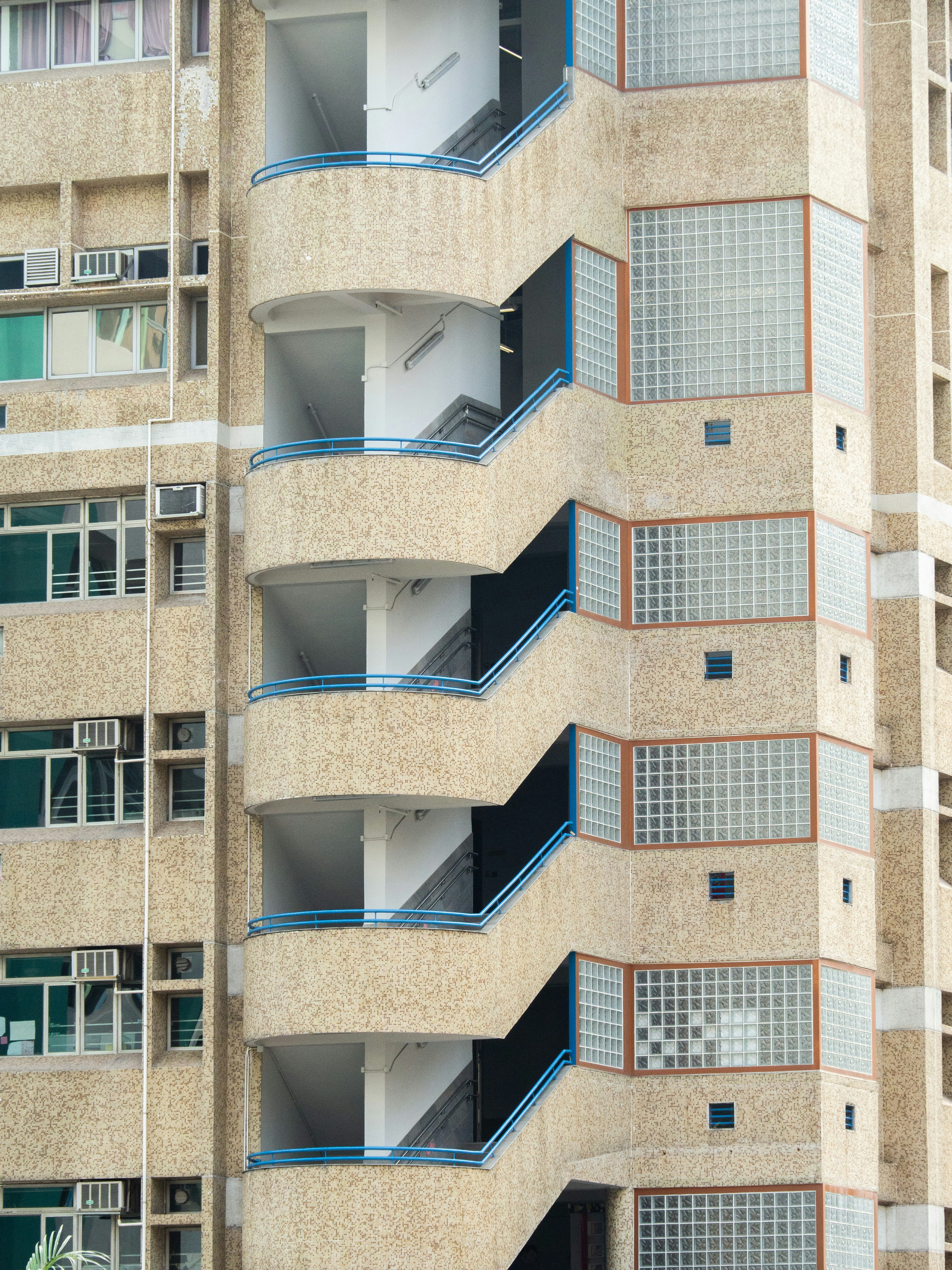 Curved Balconies Cascade Across a Bricked Facade