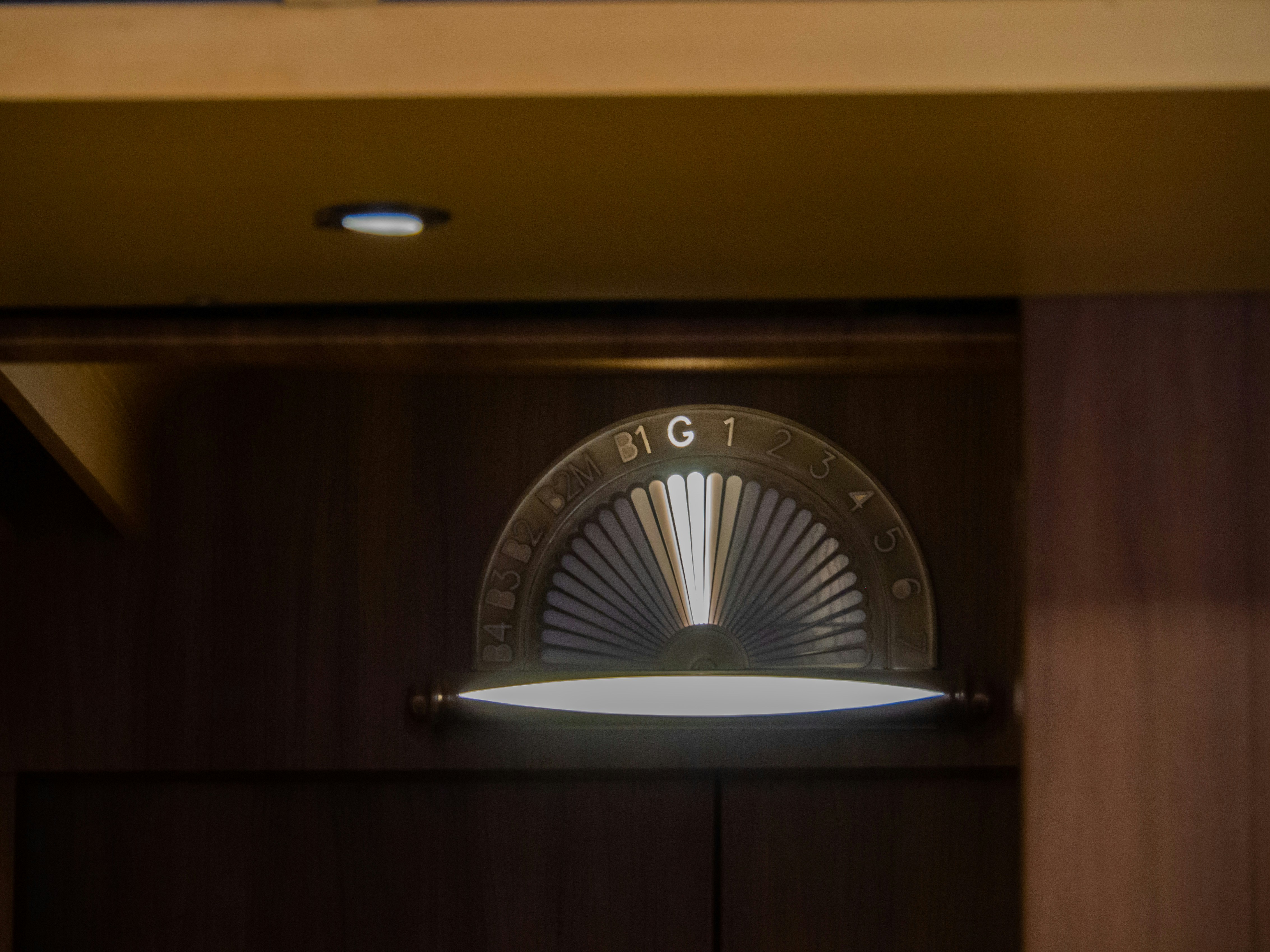 Circular Art Deco Dial Illuminated Above a Dark Desk Niche