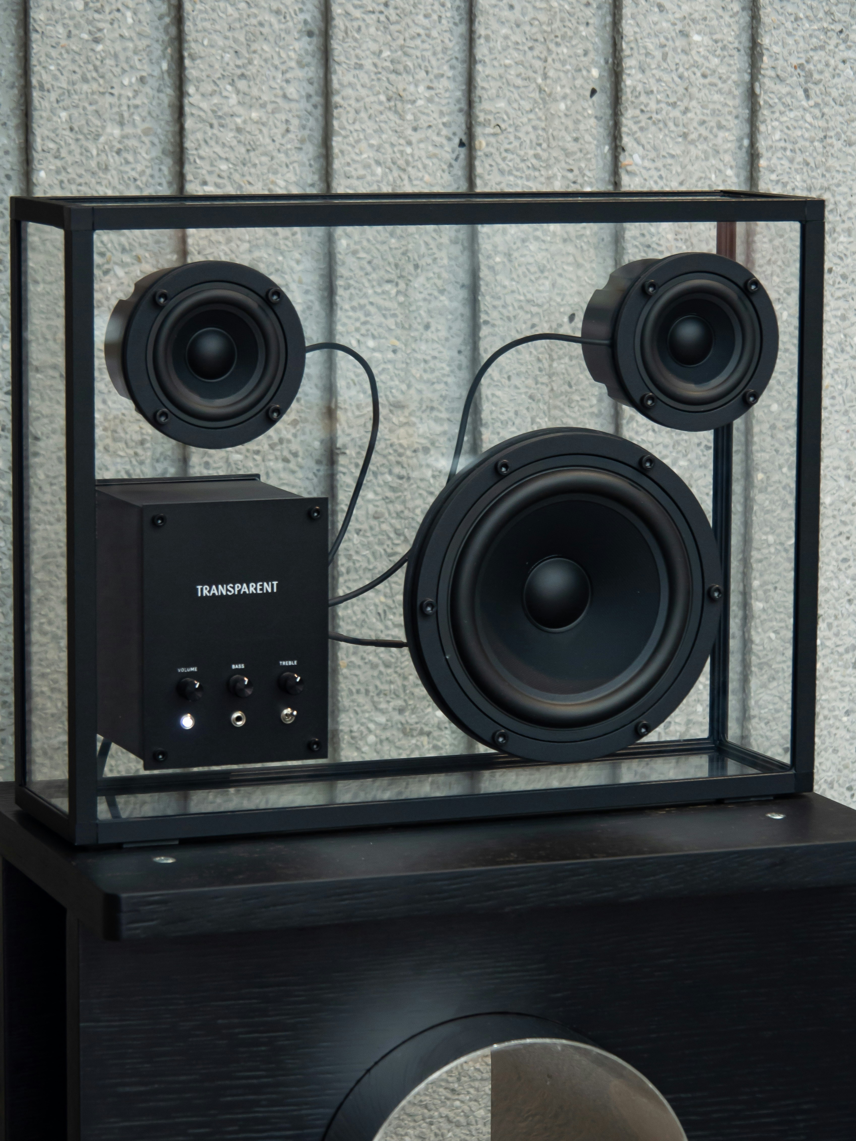 Exposed Circuitry: A Modern Speaker Rig encased in a Glass Frame