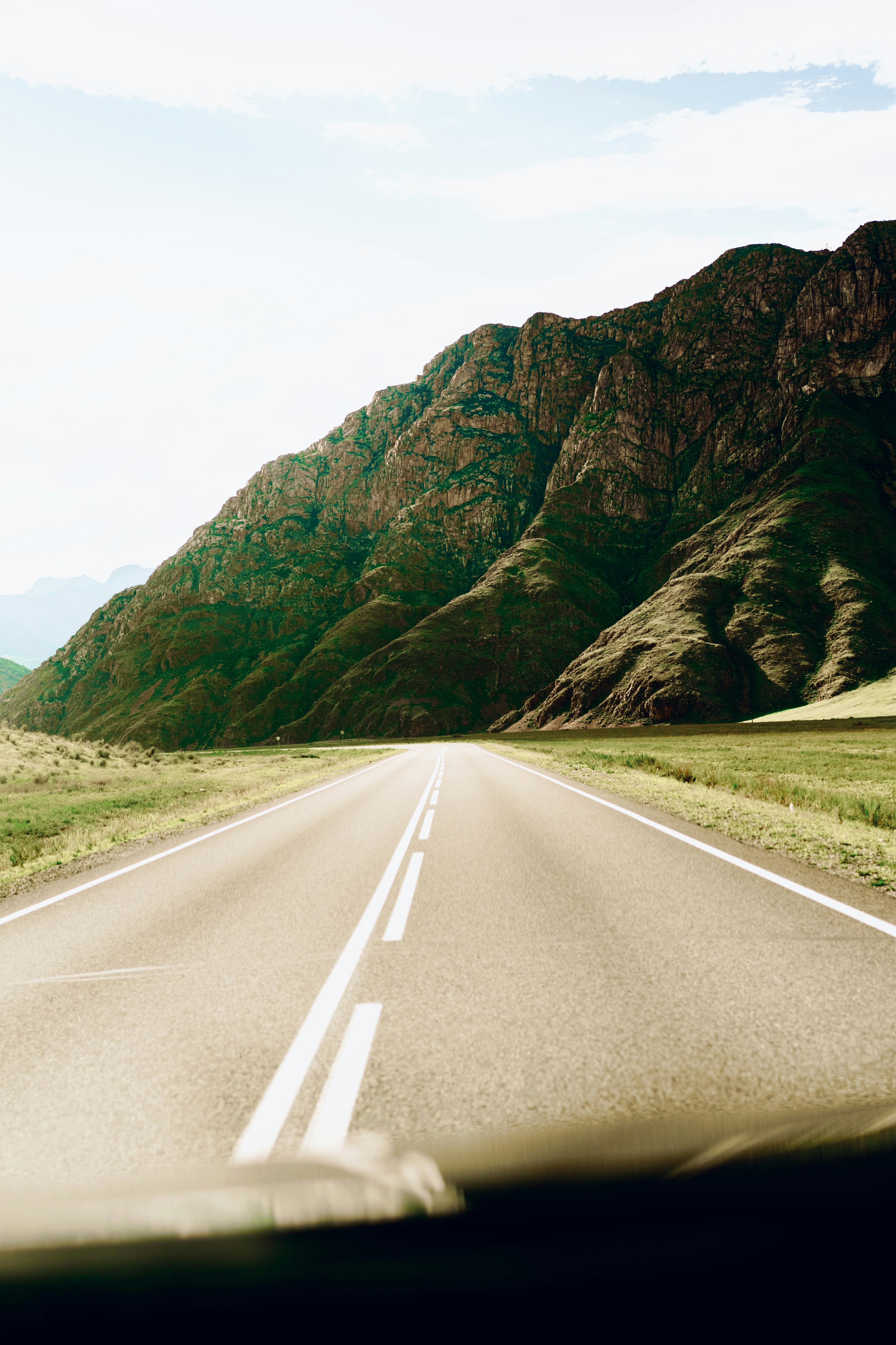 Deserted Highway Toward Rugged Peaks
