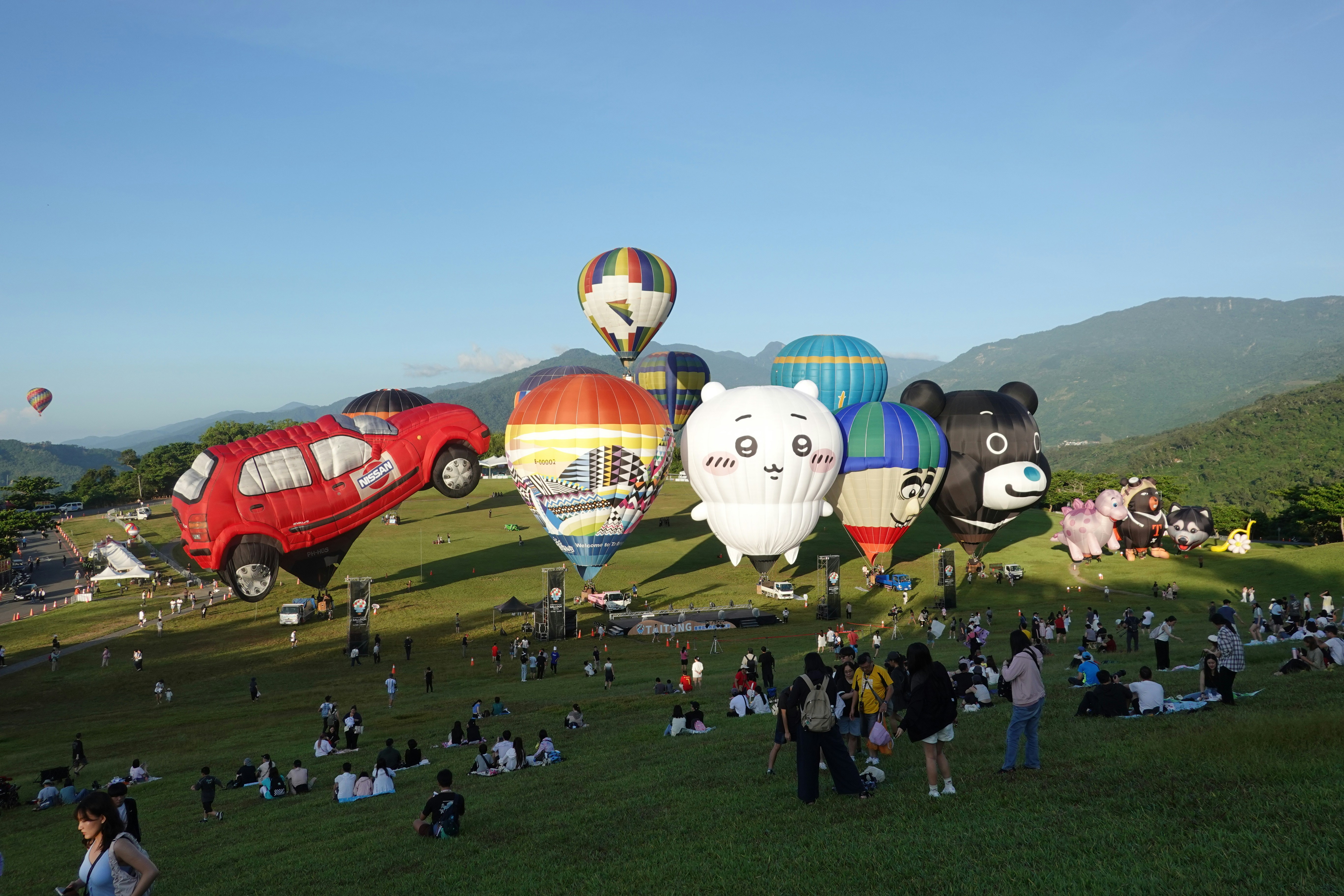 Floating Carnival: Hot-Air Giants over the Hill