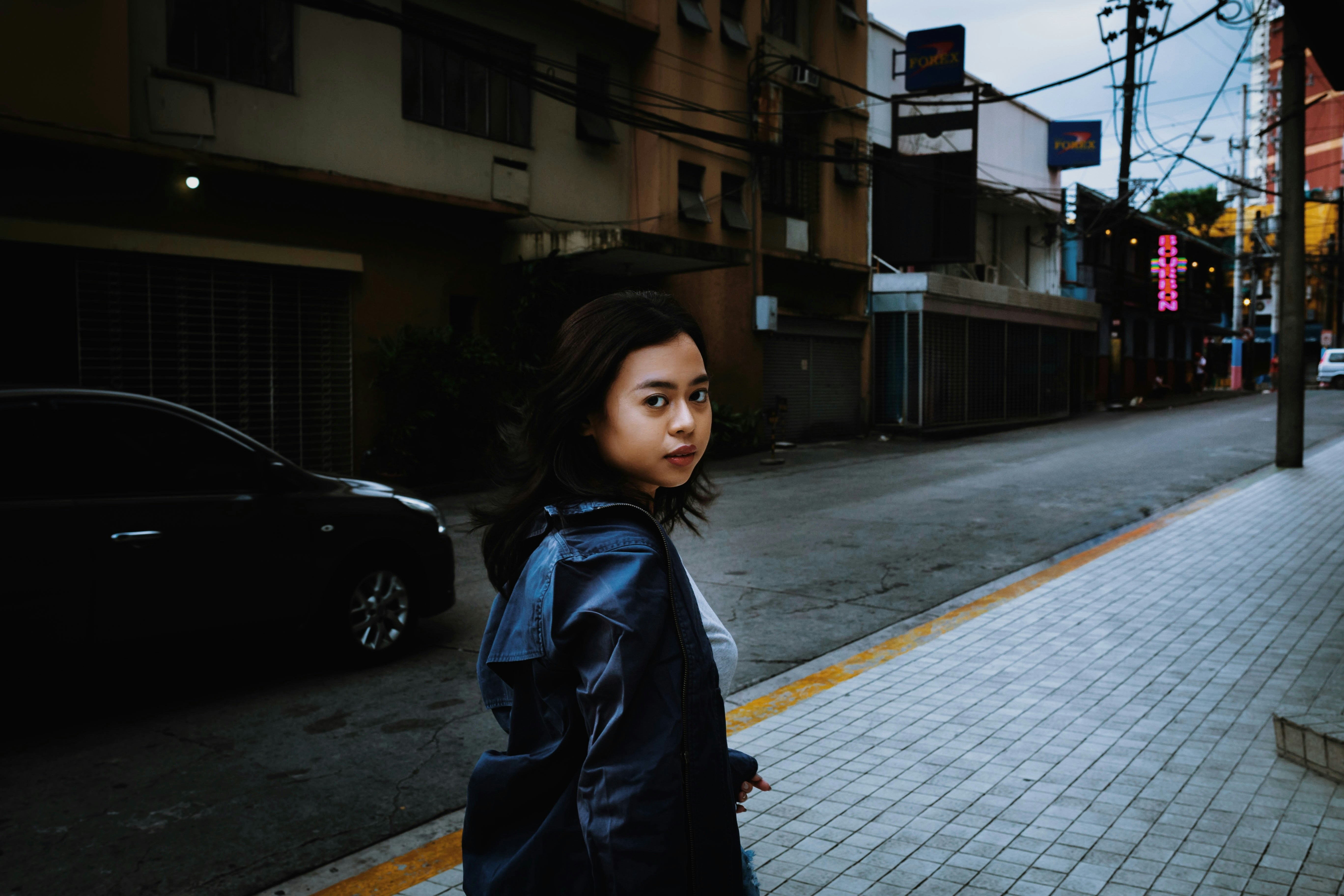Nightwalk Portrait: Streetlight Glimmer on a Candid Gaze
