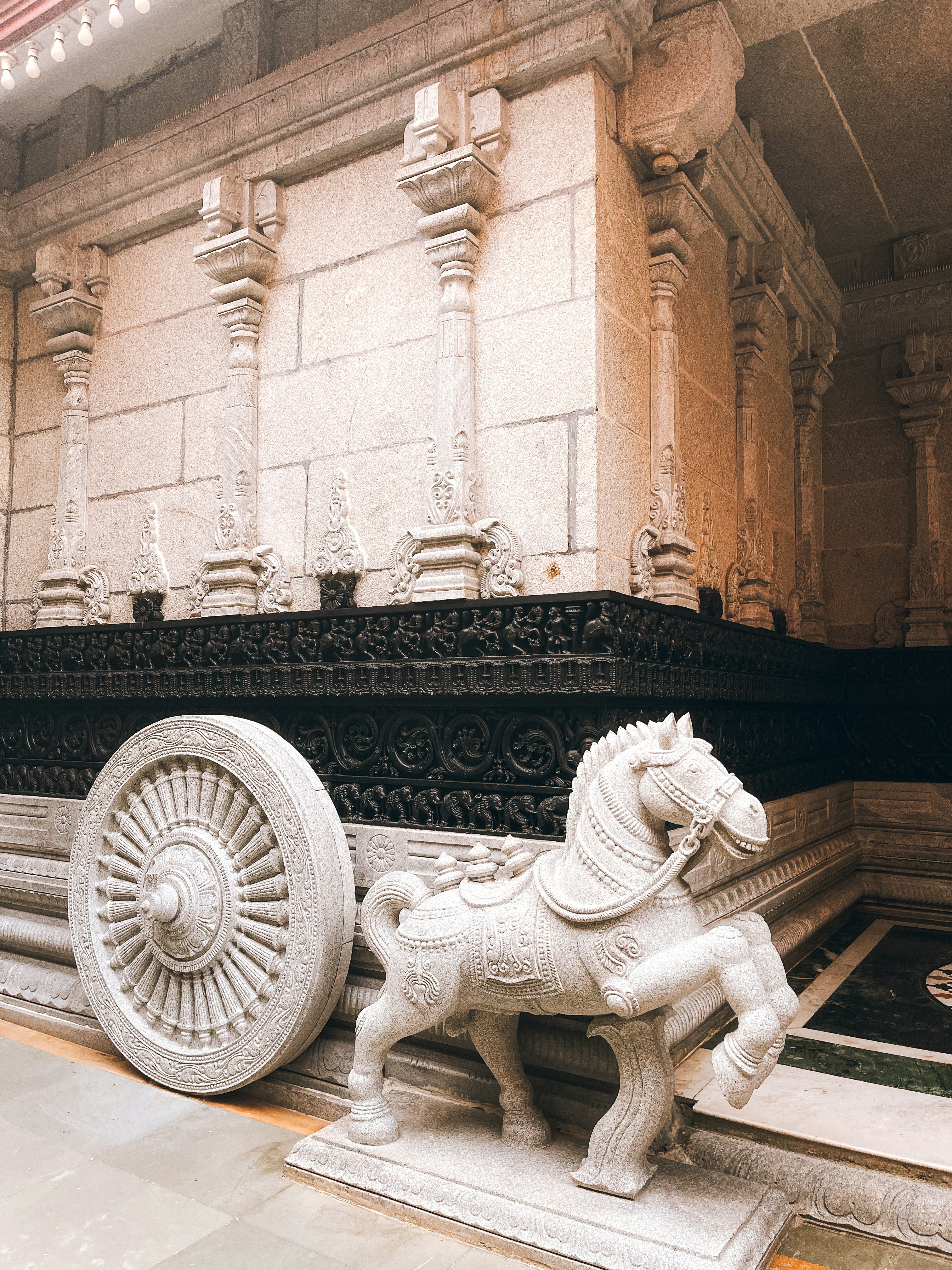 Stone Carriage in Reserve: A Horse-Drawn Relic Guarded by Carved Panels