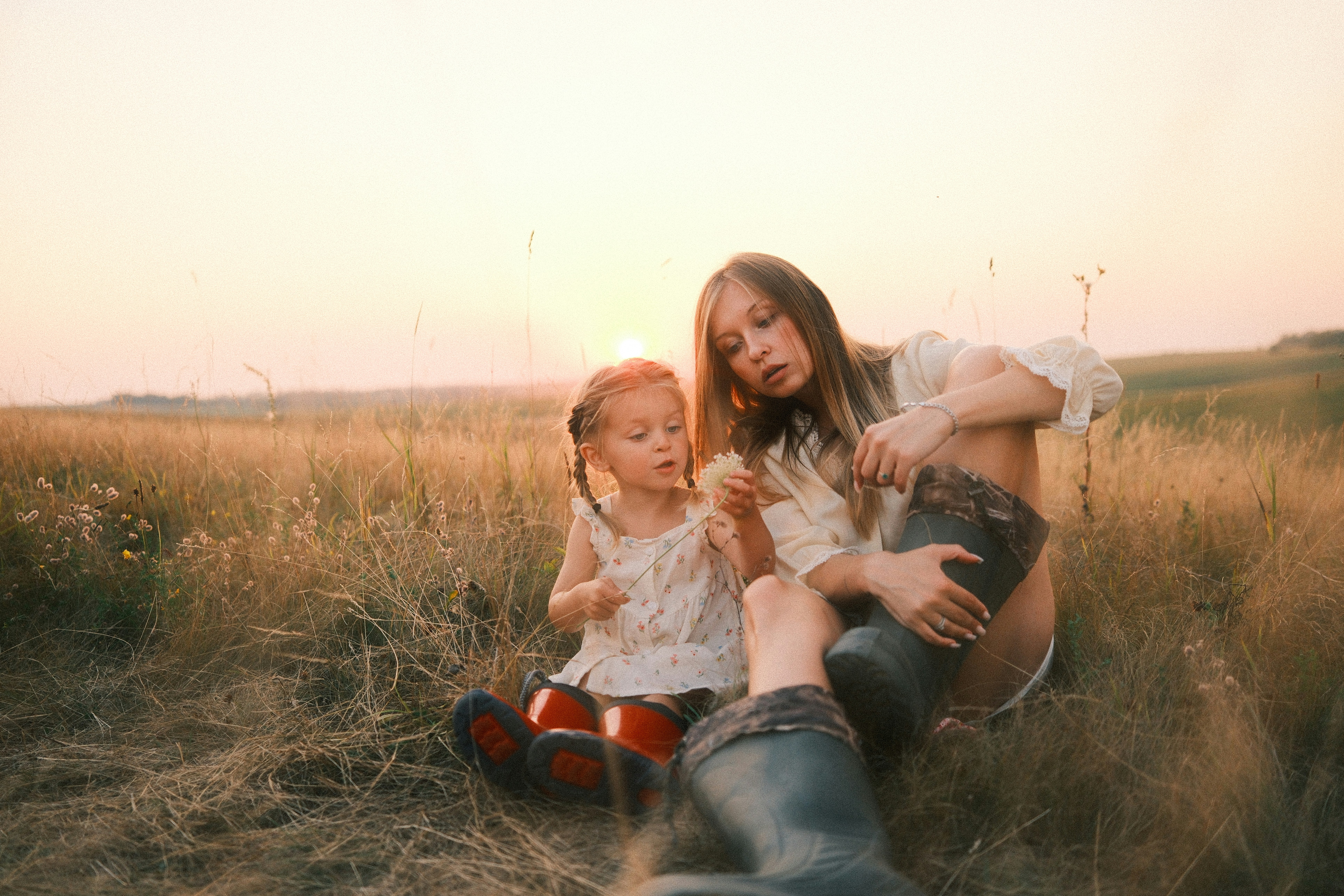 Sunlit Meadow: Siblings on a Quiet Sunset Afternoon
