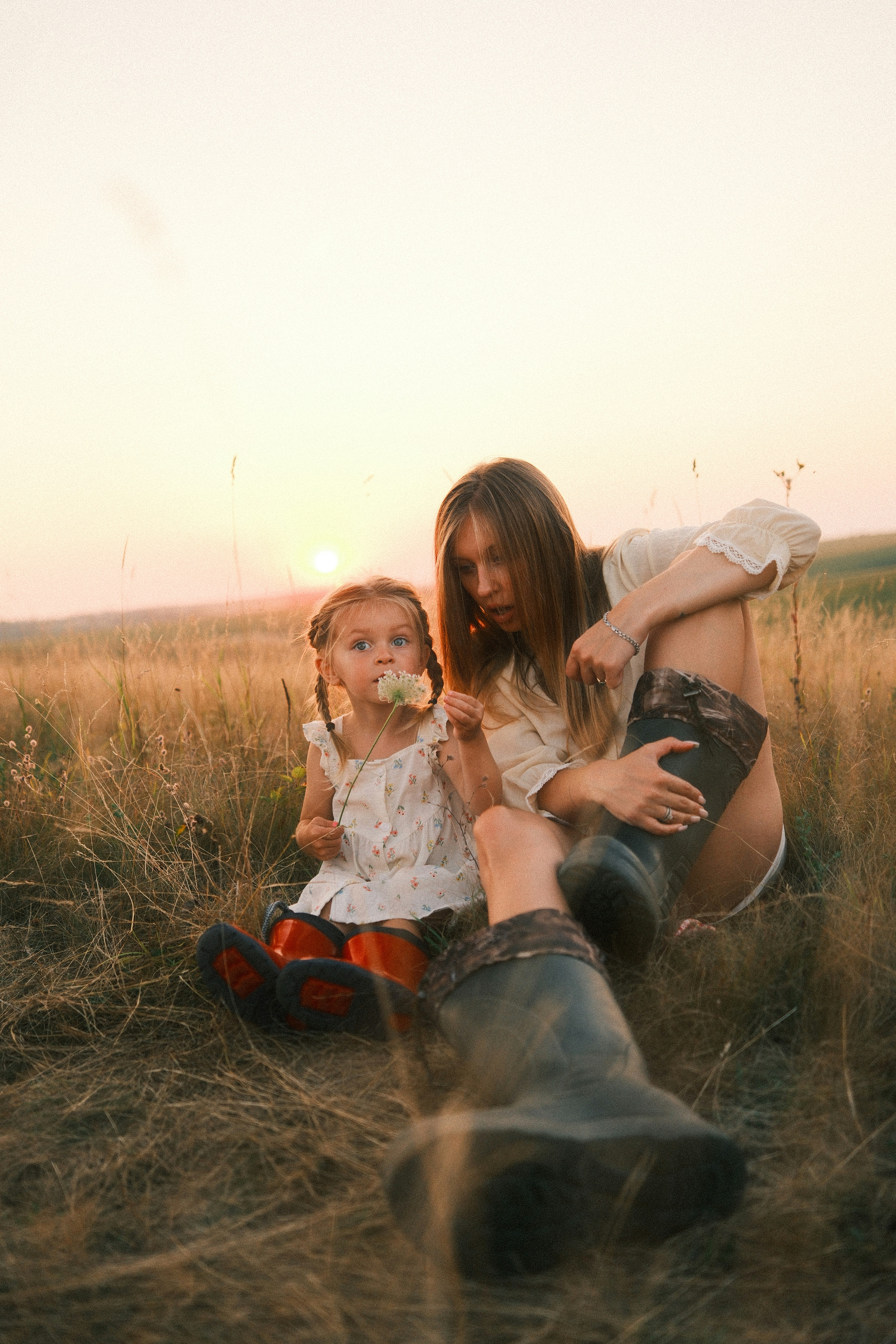 Sunlit Sunset Moments: Mother and Daughter in a Golden Field