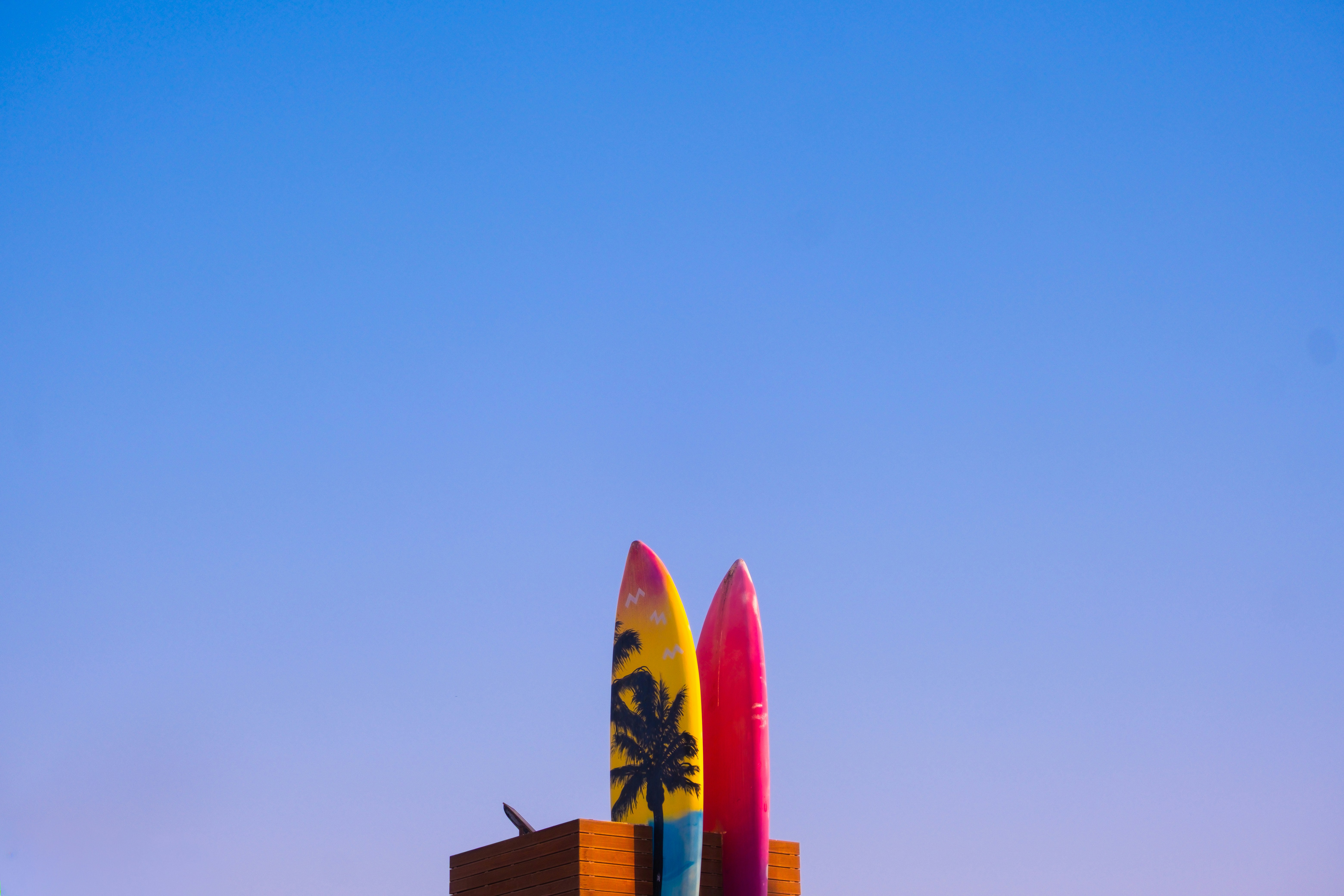 Surfboard Silhouette: Coral Sunrise on a Rooftop