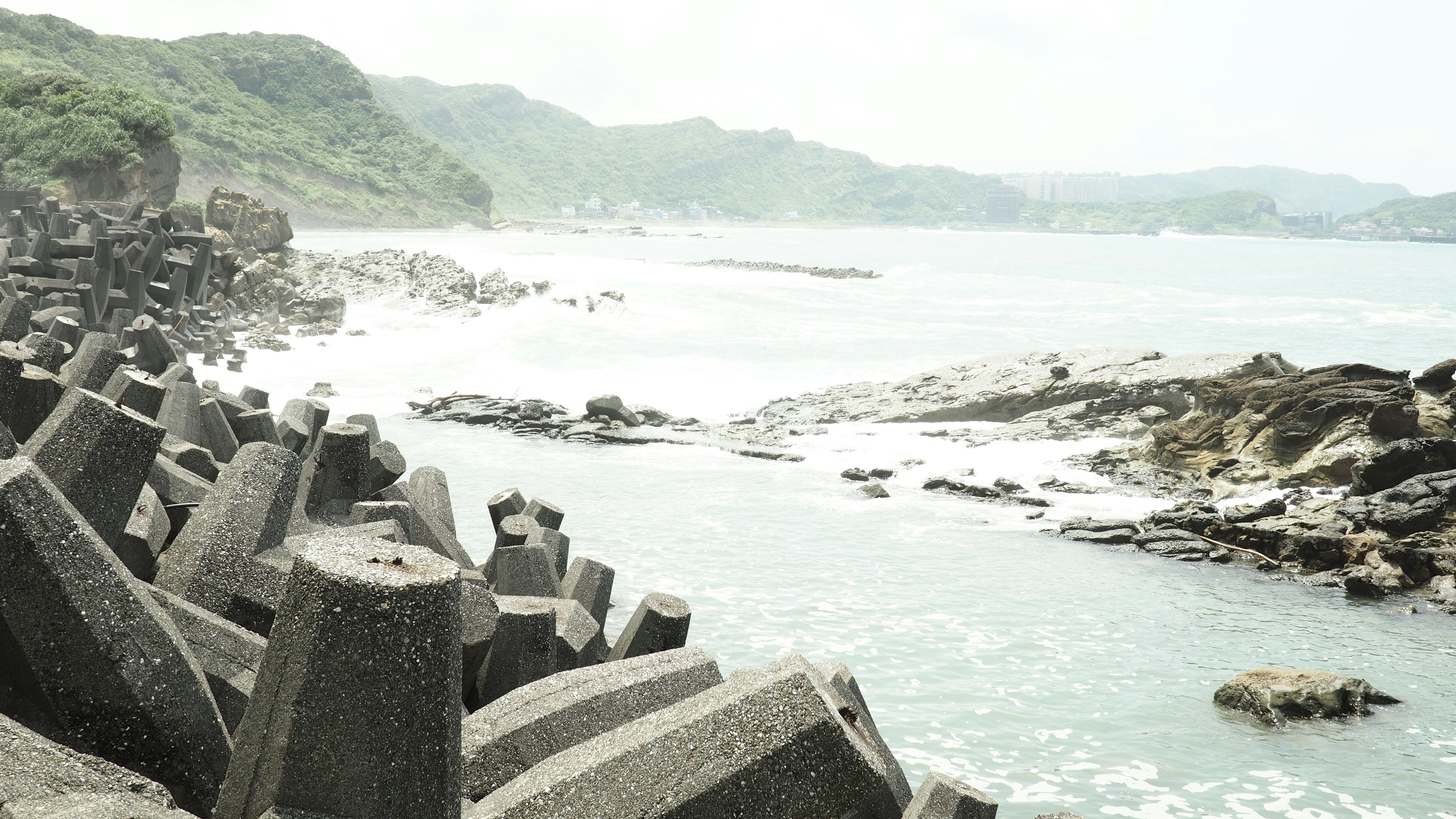 Rugged Breakwaters Receding into a Misty Sea