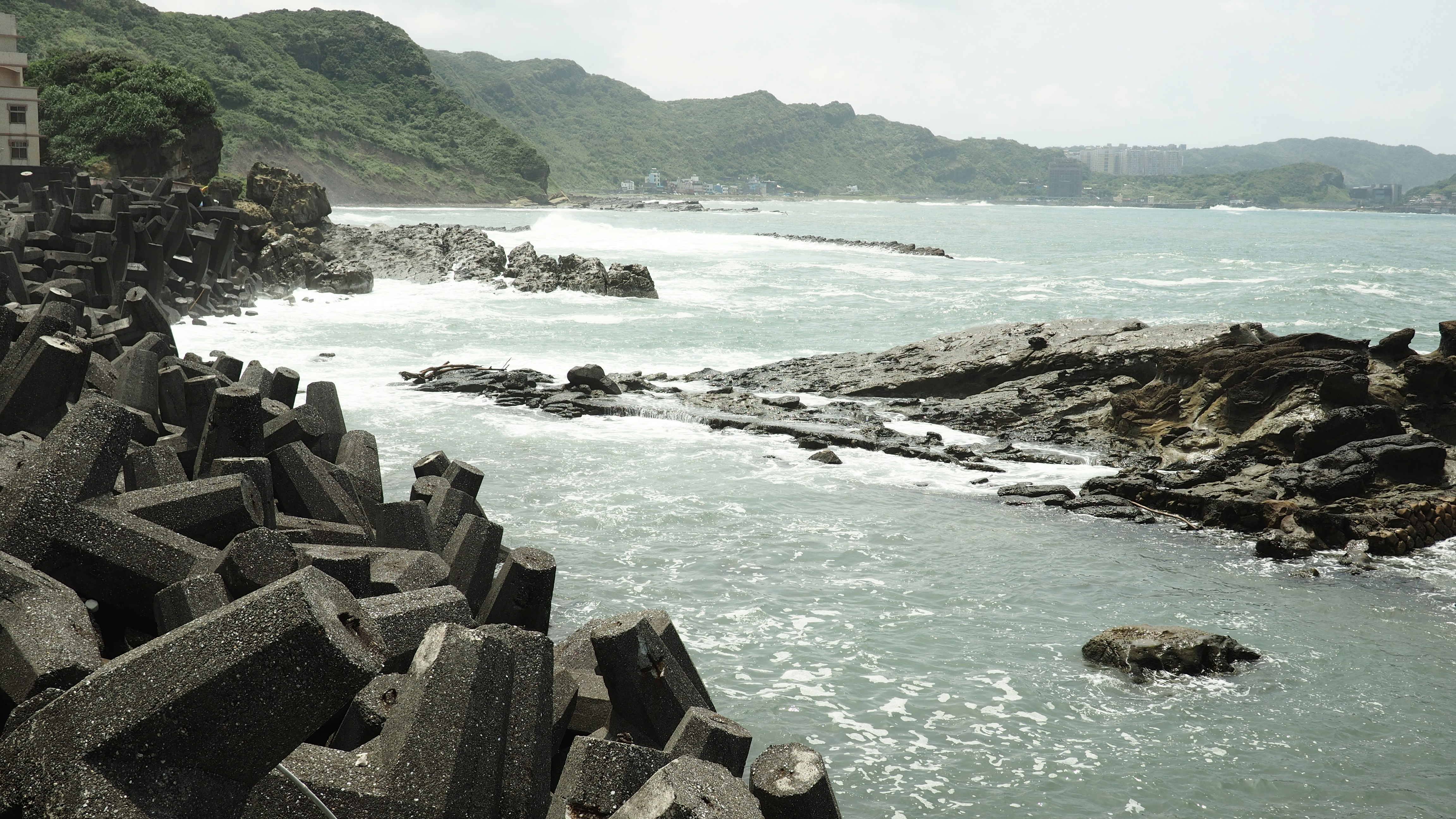 Rugged Breakwaters Keep Watch Over a Misty Coastline