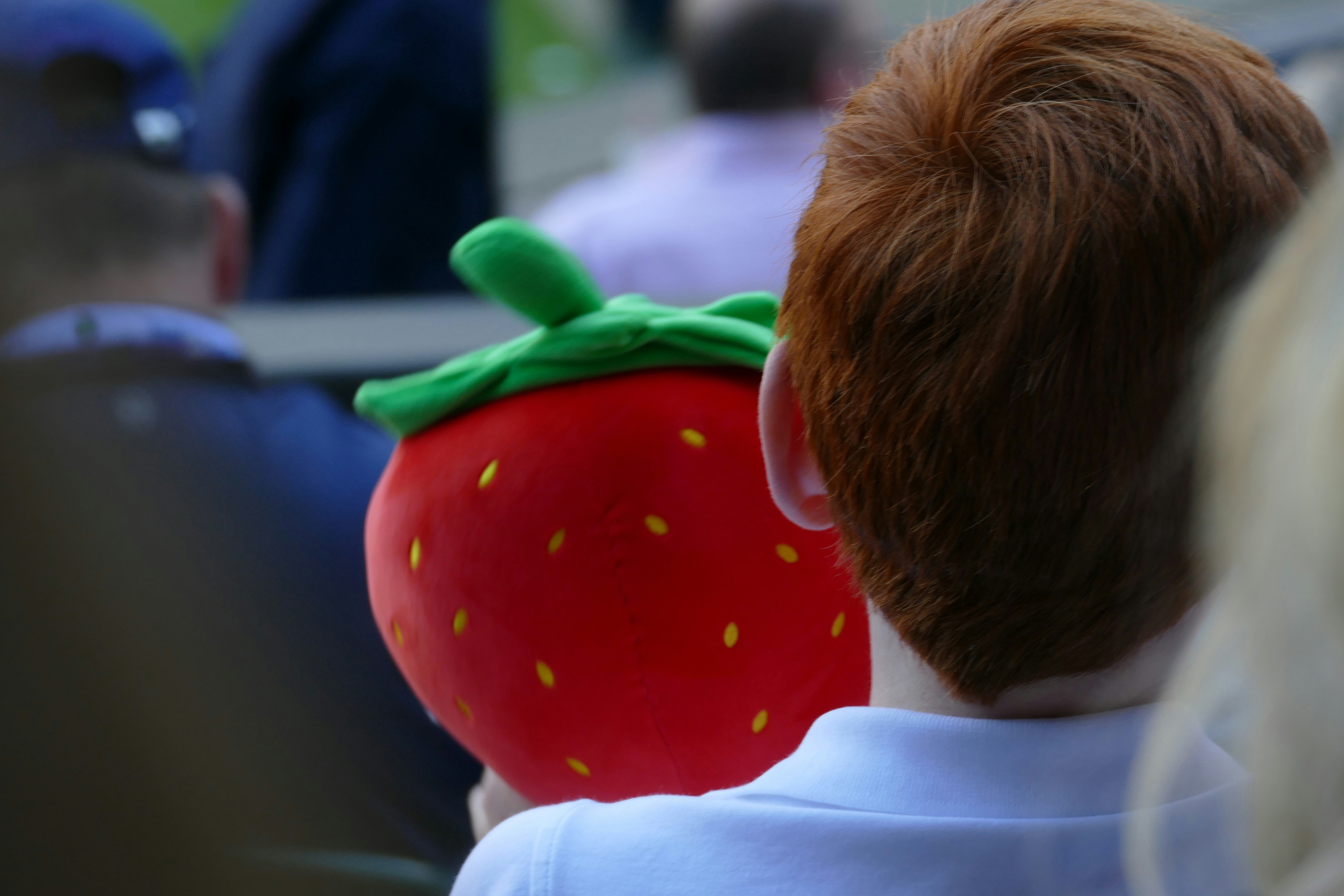 Strawberry Mascot in a Crowd: Quiet Red Amidst the Heads