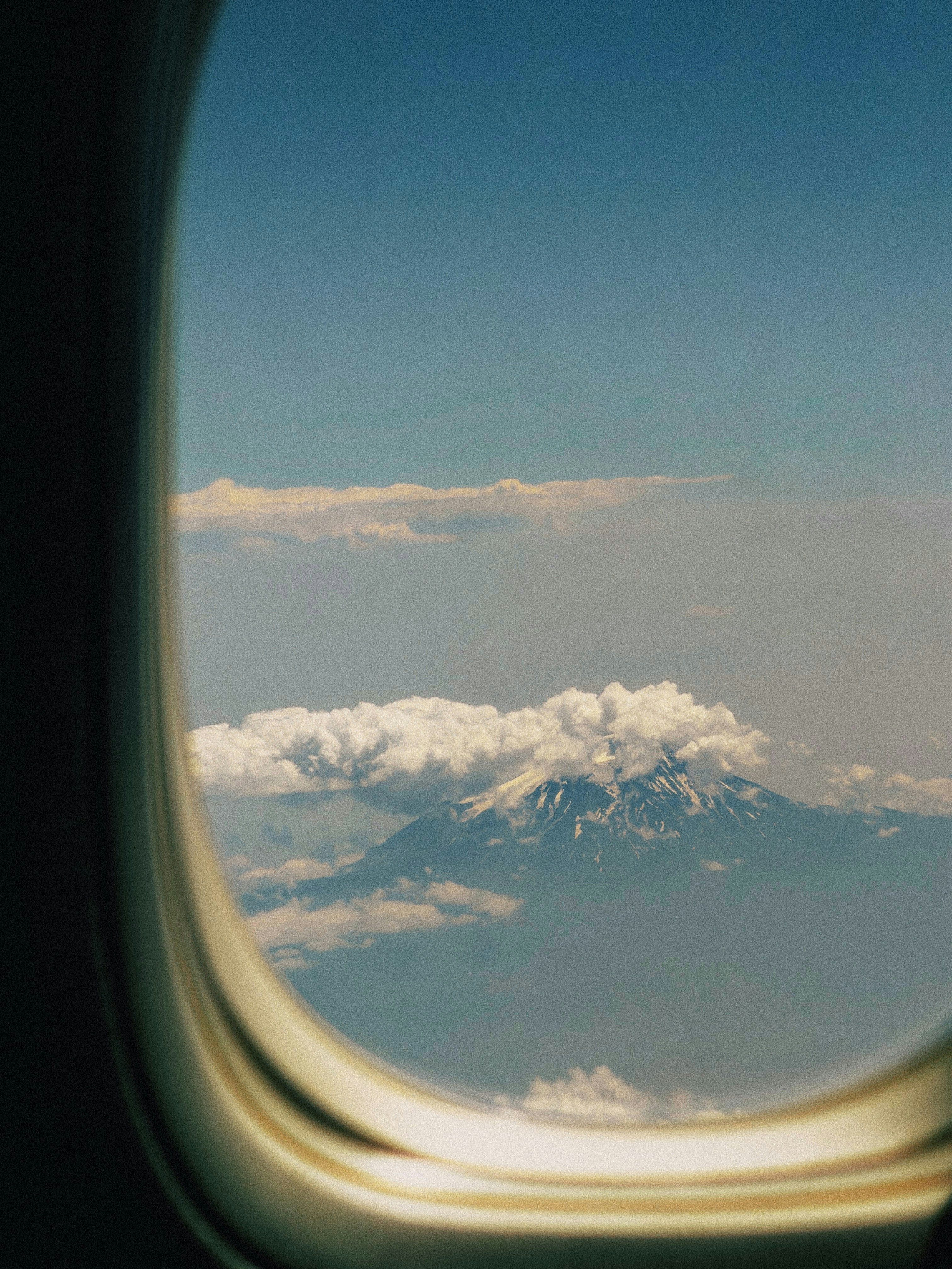 Floating Peak: A Mountain View Framed by Aircraft Window