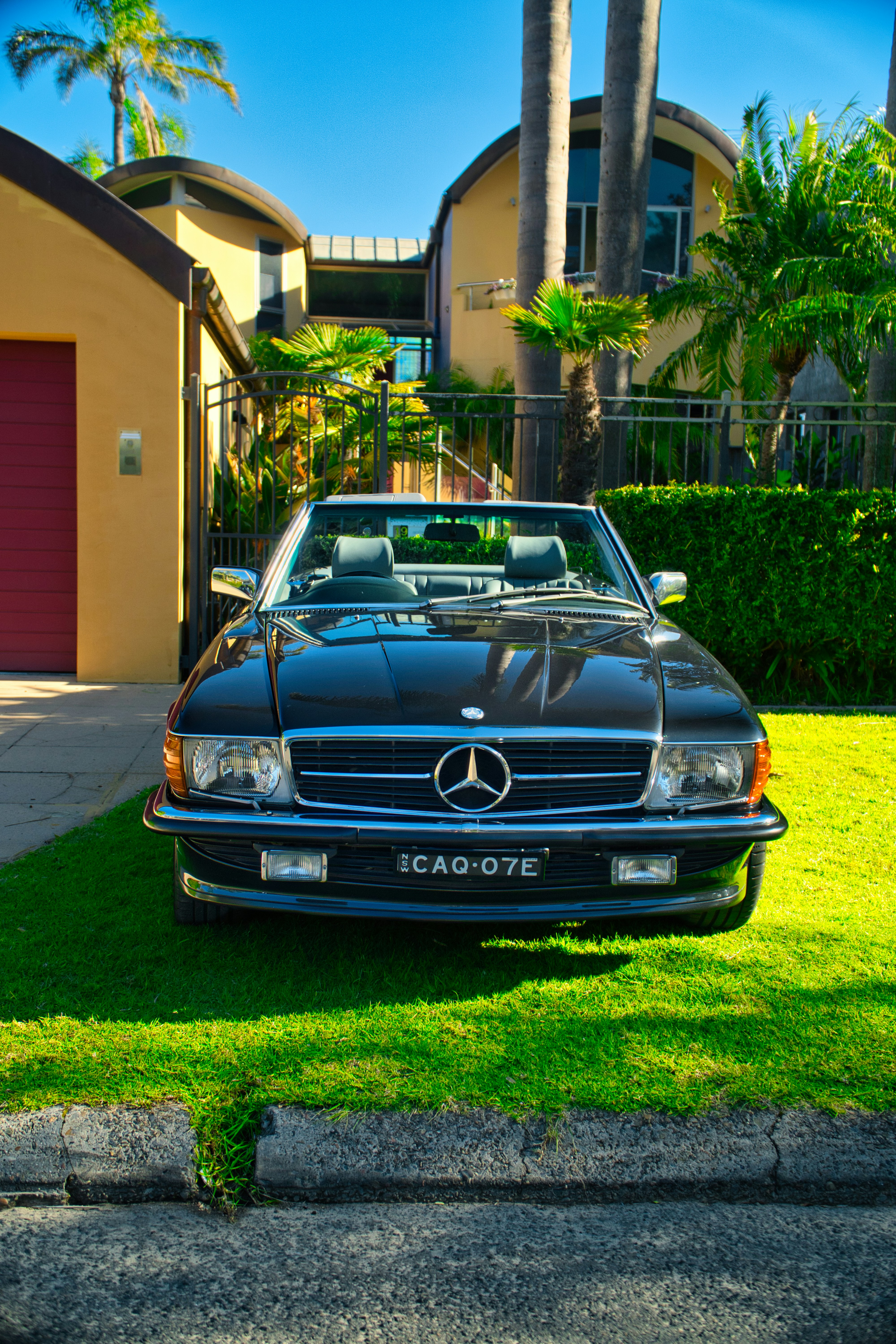 Front-and-Cun car in a sunlit suburban driveway
