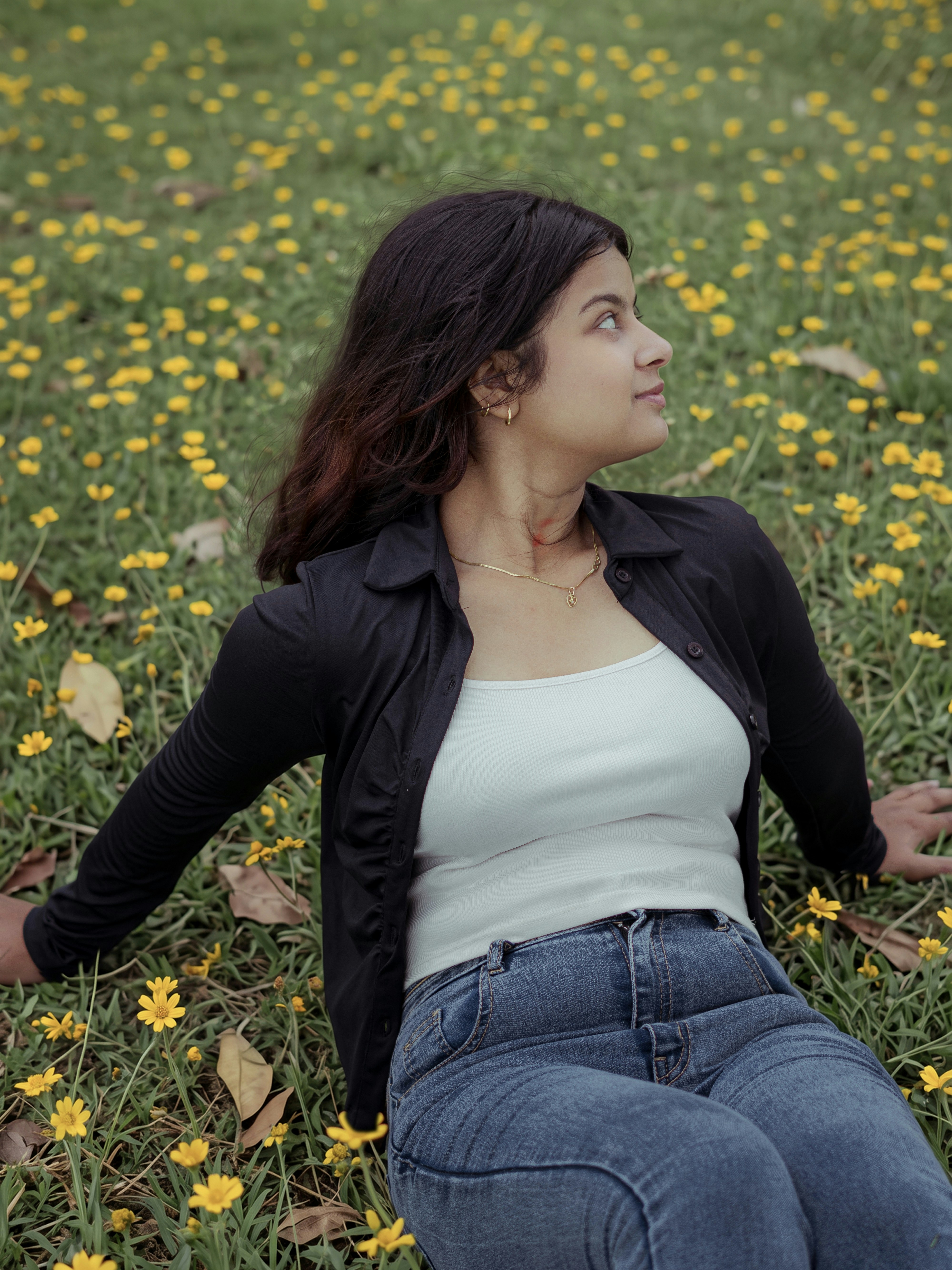 Sunlit Poise: A Portrait Among Golden Dandelions