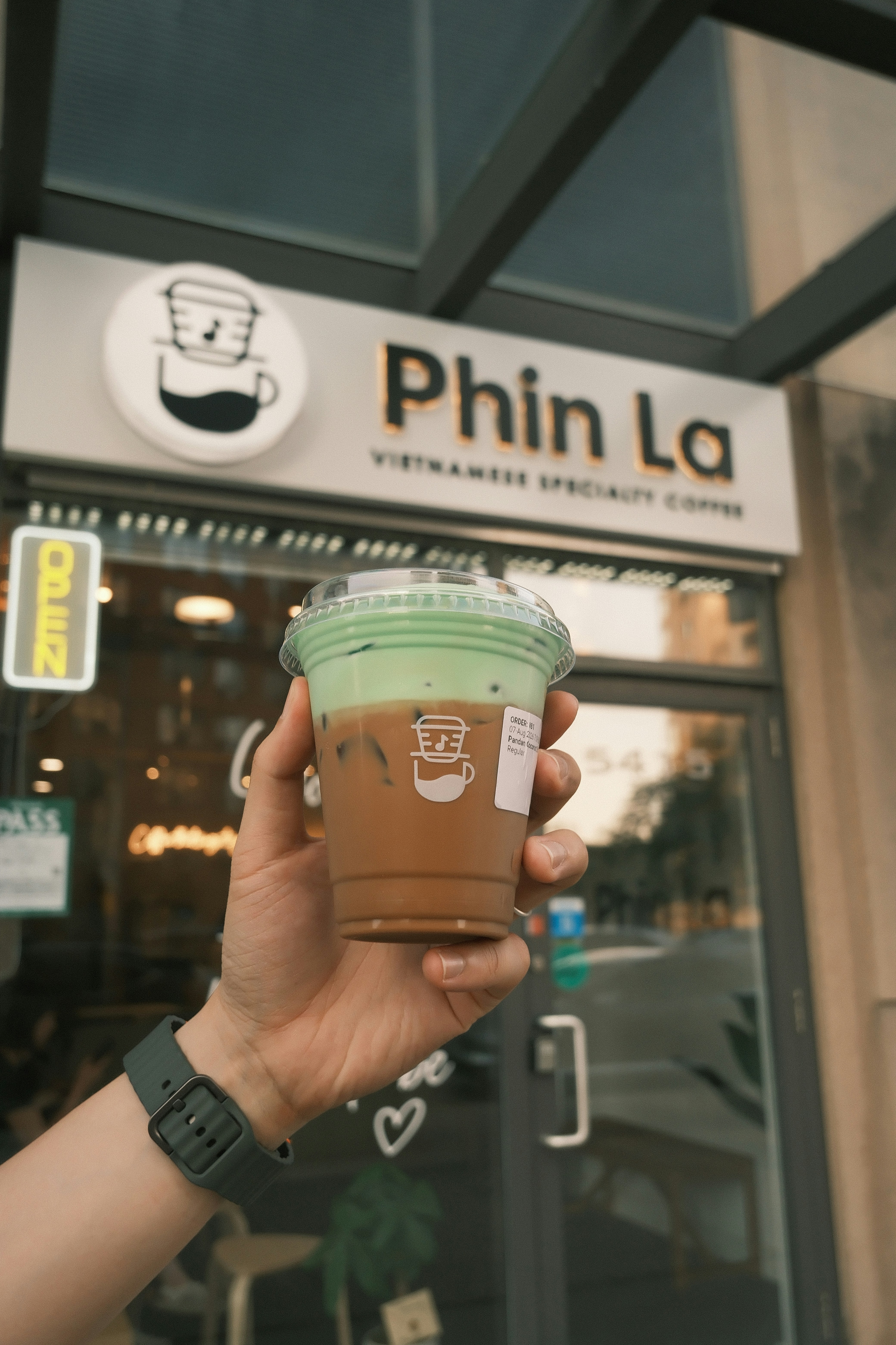 Hand-held Cold Brew: A Delicate Latte Moment in Front of Phin La