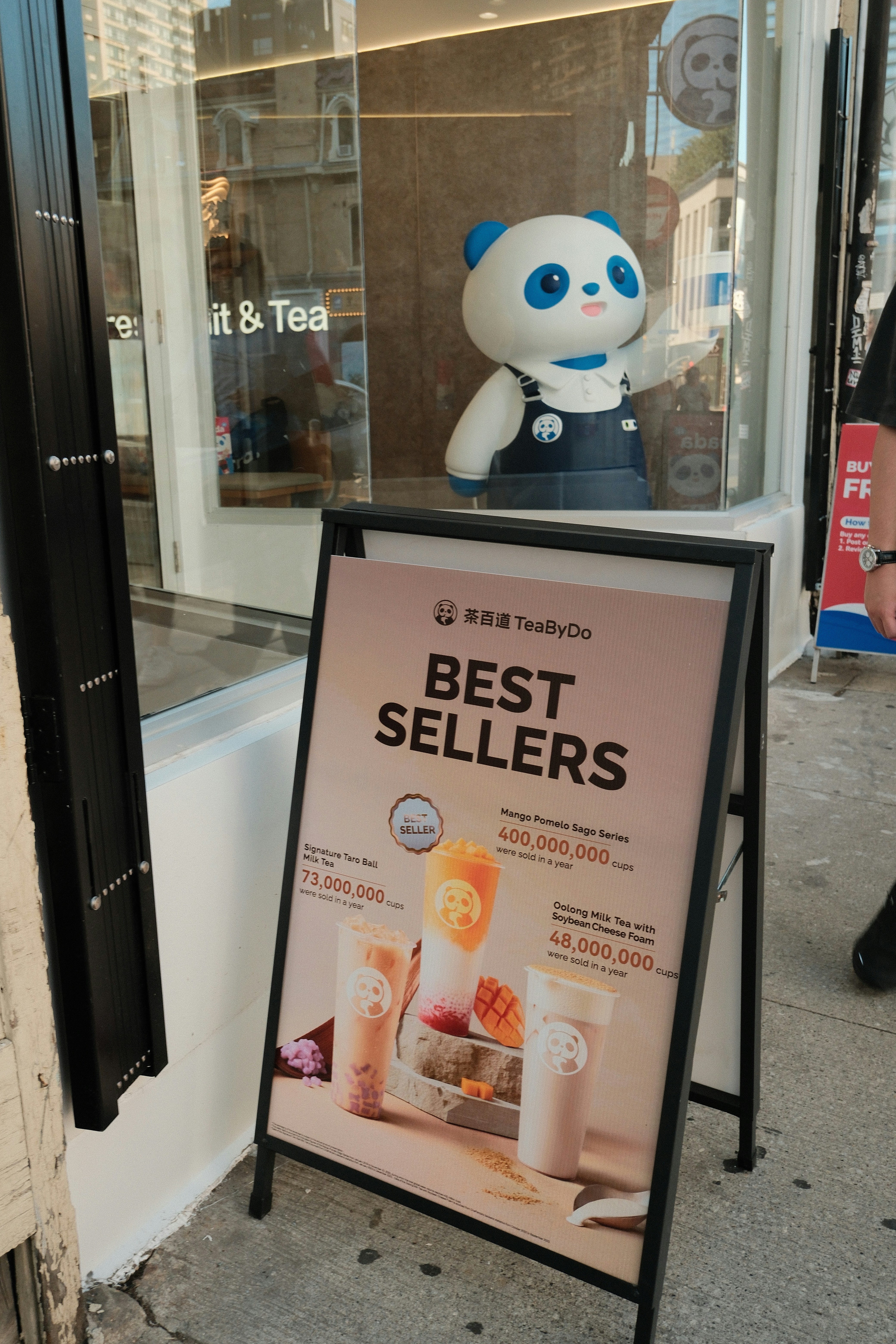 Panda Mascot Guarding a Best Sellers Sign